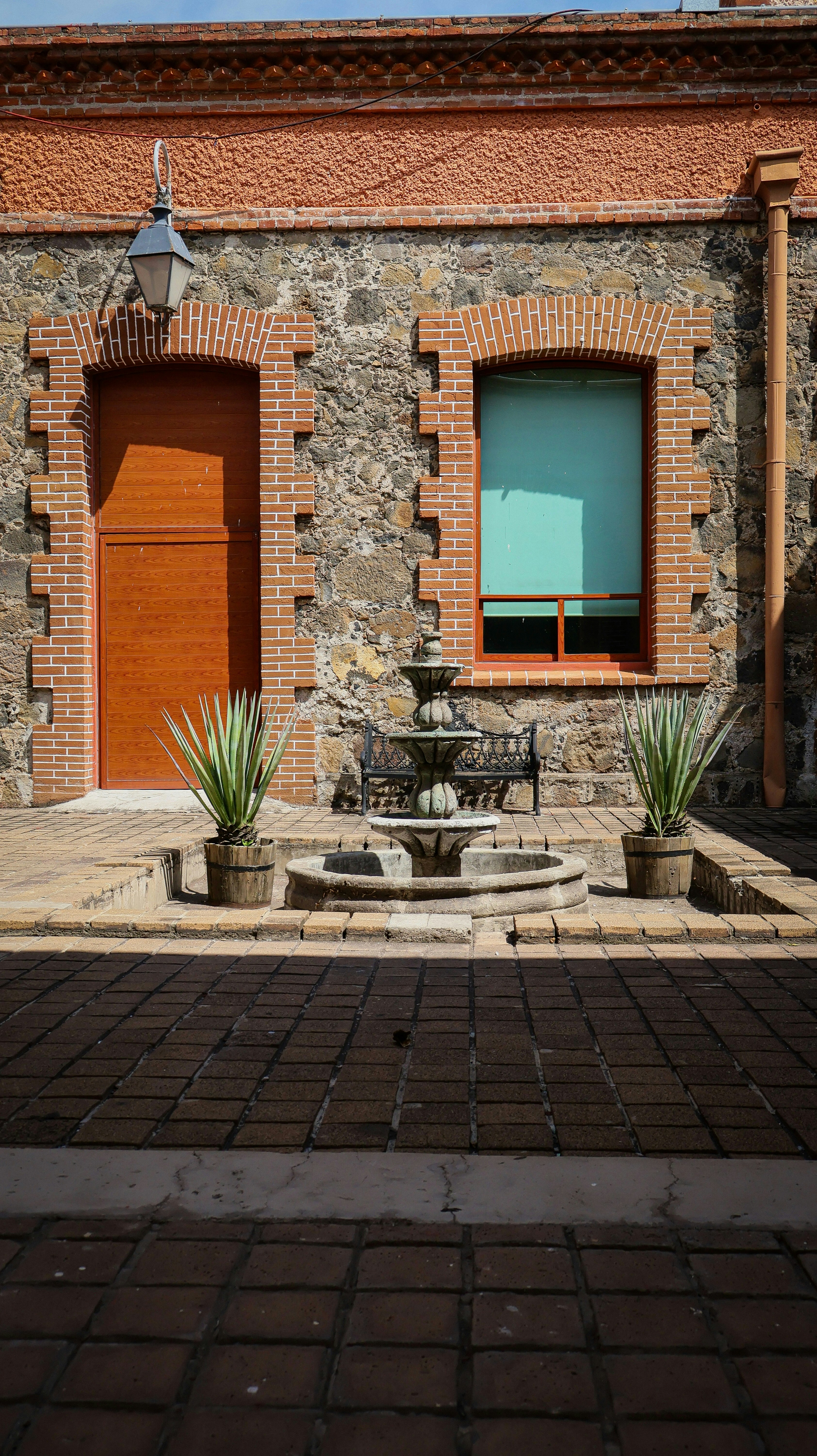 Courtyard Facade with Stone Archway and Fountain