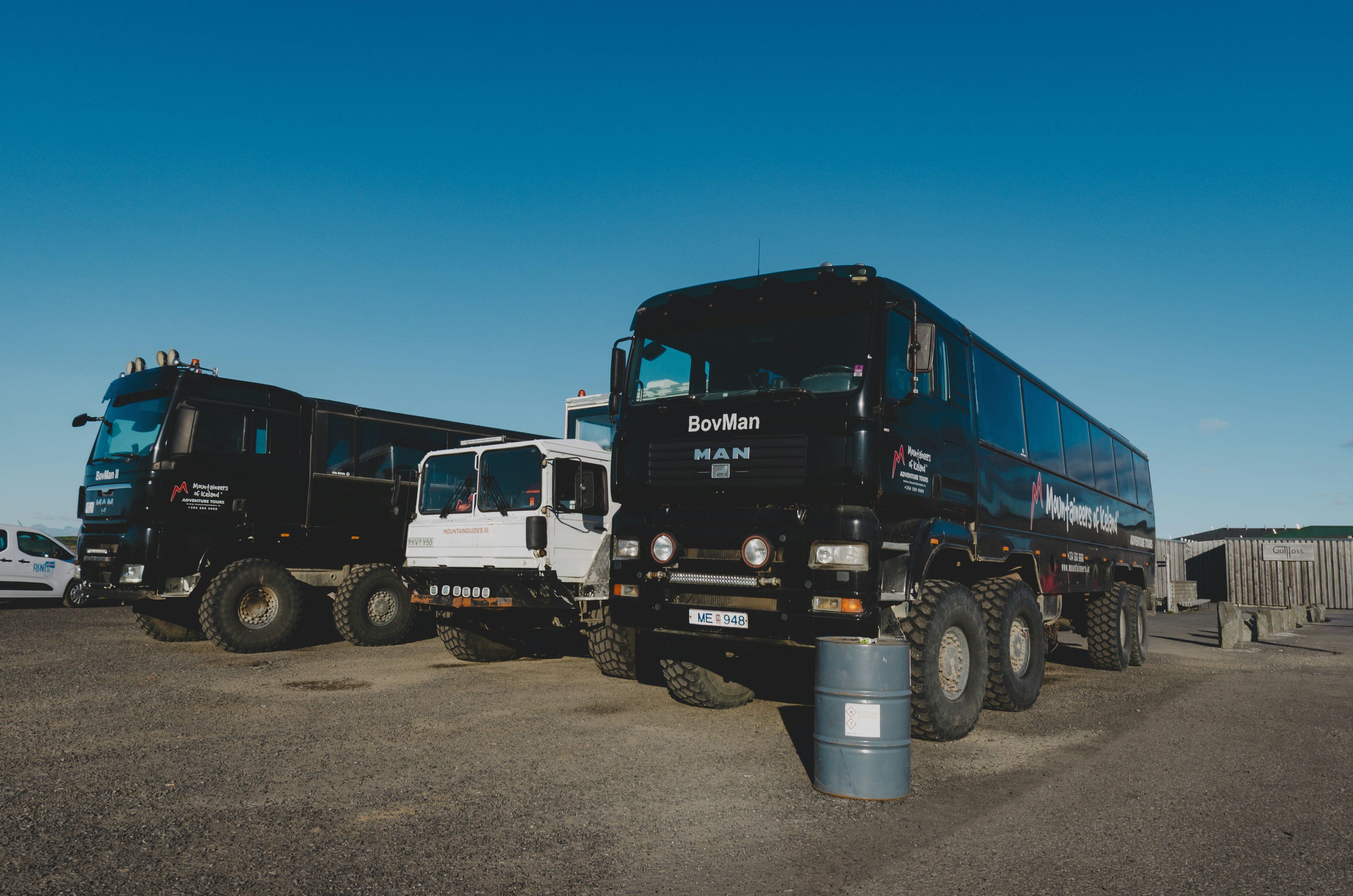 Fleet at the Edge: A Row of Heavy-Duty Giants in the Open Yard