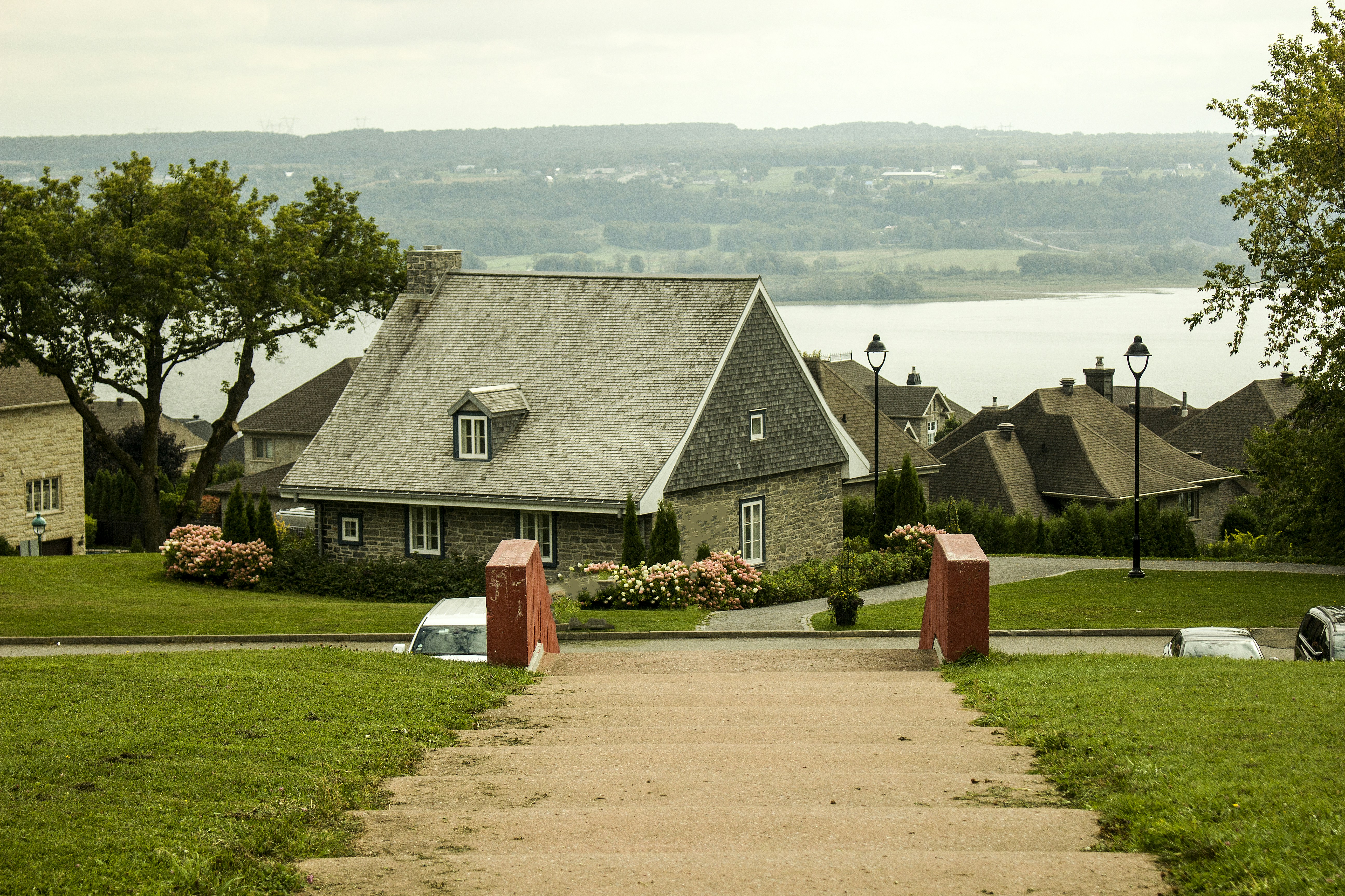 Quaint Lakeside Hamlet with a Centered Chalet and Road Approach
