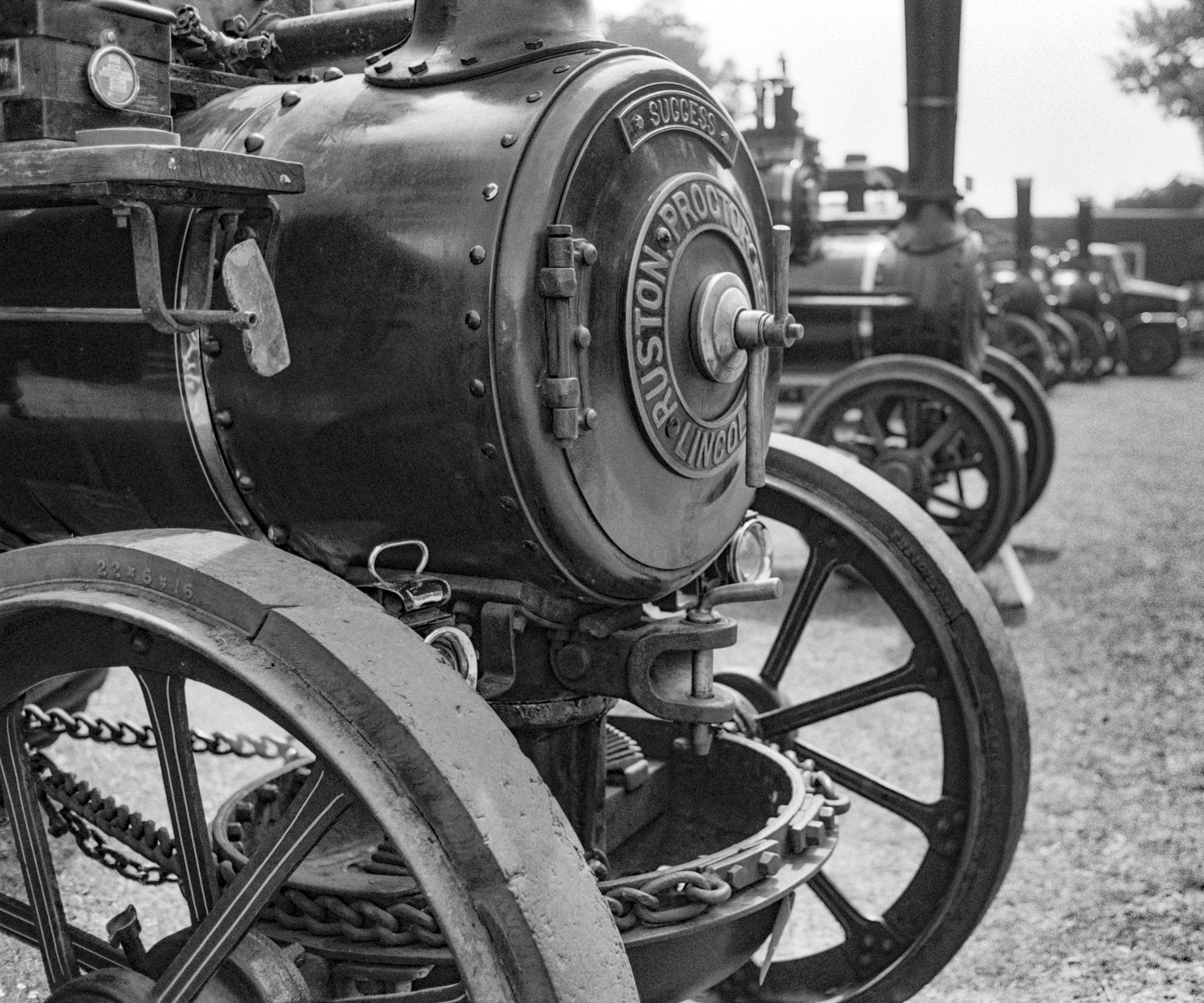 Close-up of a vintage steam locomotive’s drive wheel and boiler face