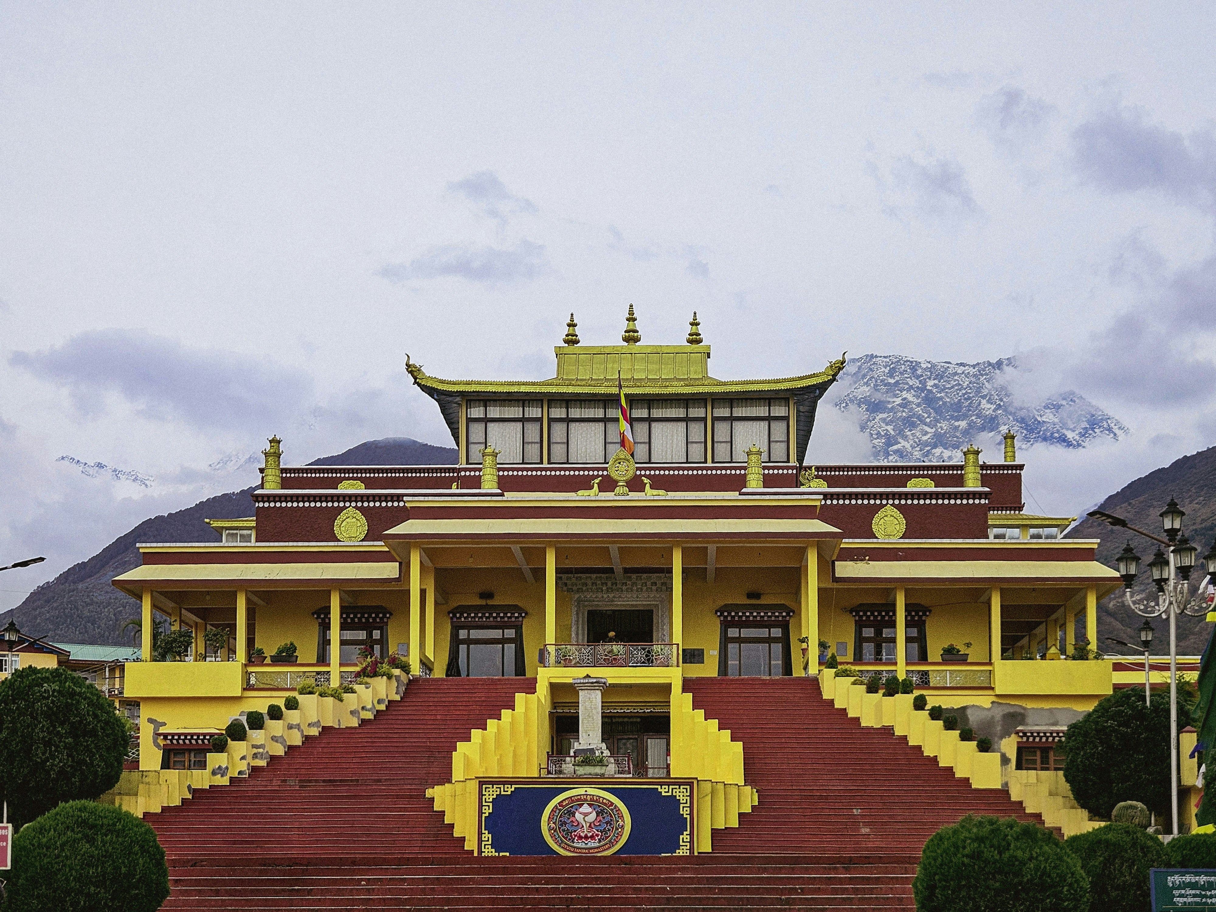 Golden Staircase to Serenity: A Tibetan Temple Rising Above Red Carpets