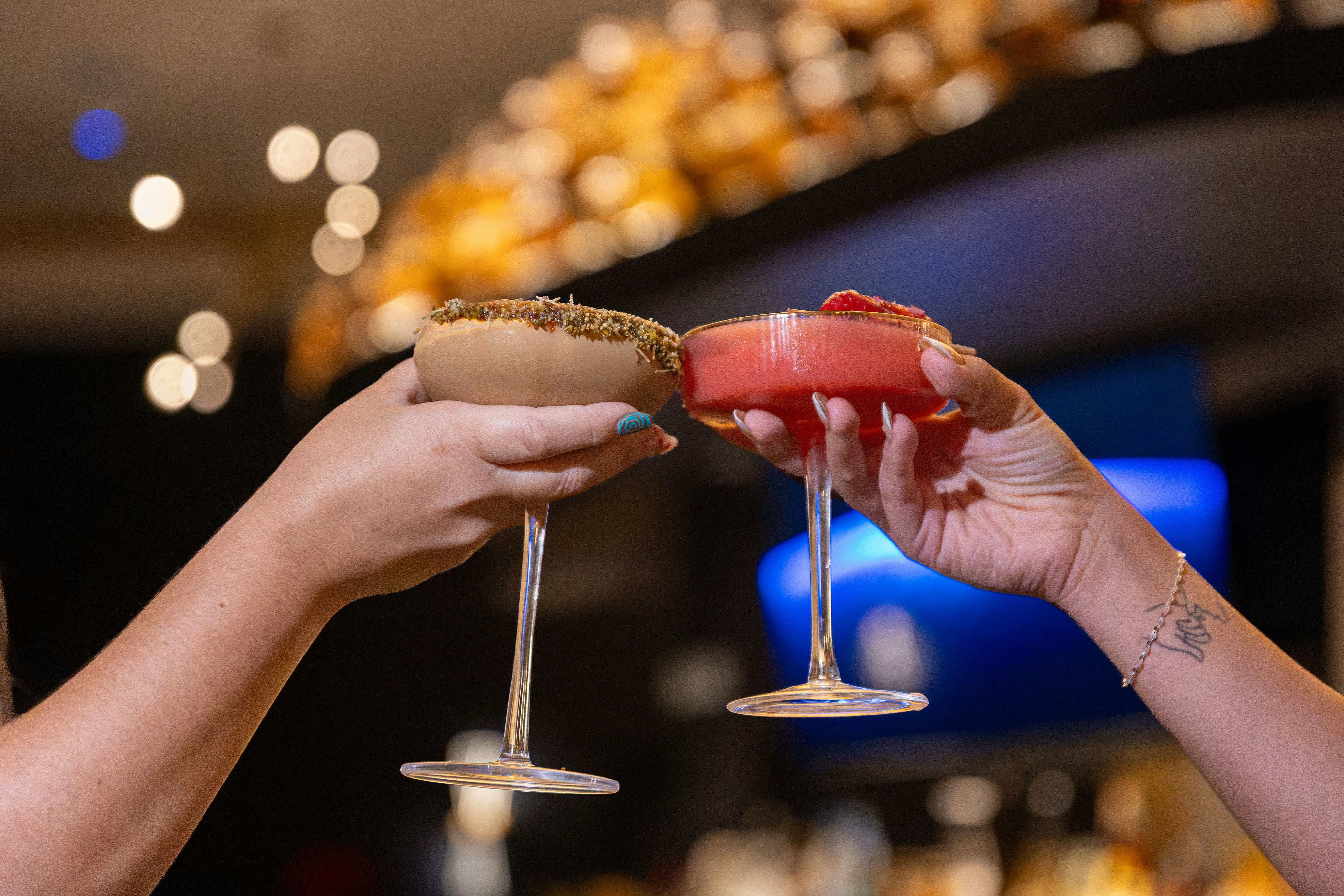 Toasting with Glasses: A Duo's Cheers in a Dim Bar