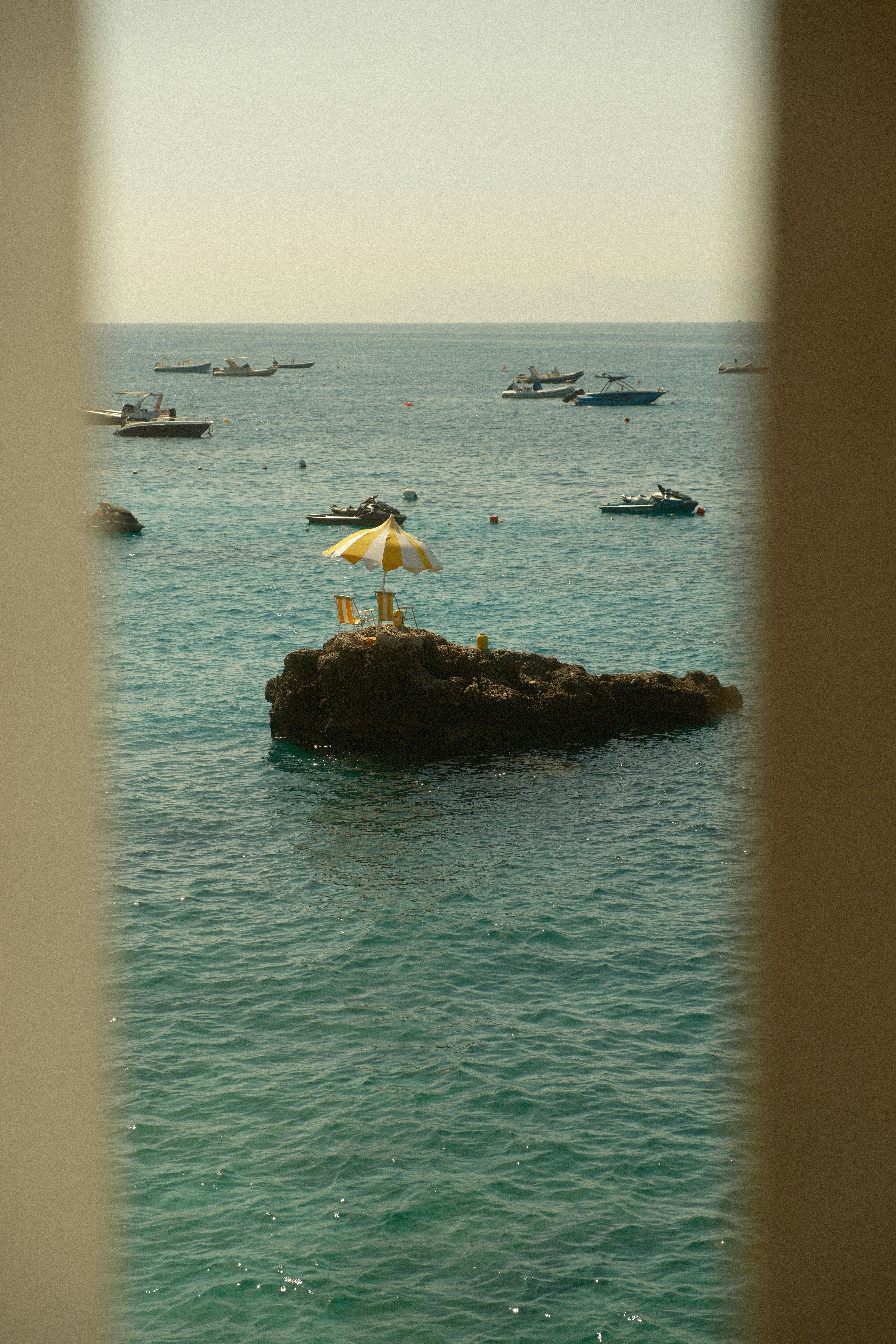 Island Foam: A Yellow Parasol Brims the Quiet Ocean