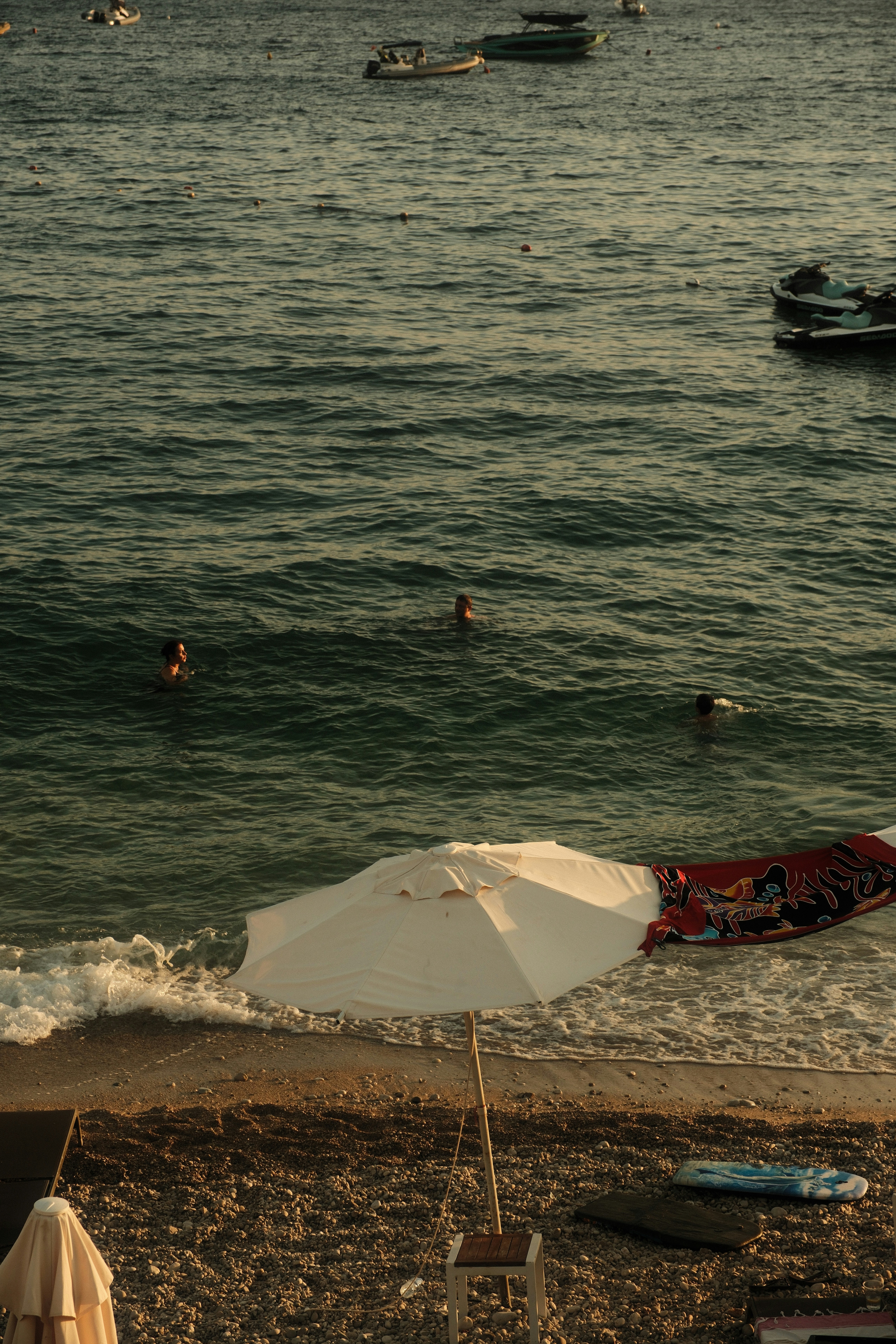 Sunlit Seaside Silhouettes by a Quiet Shore