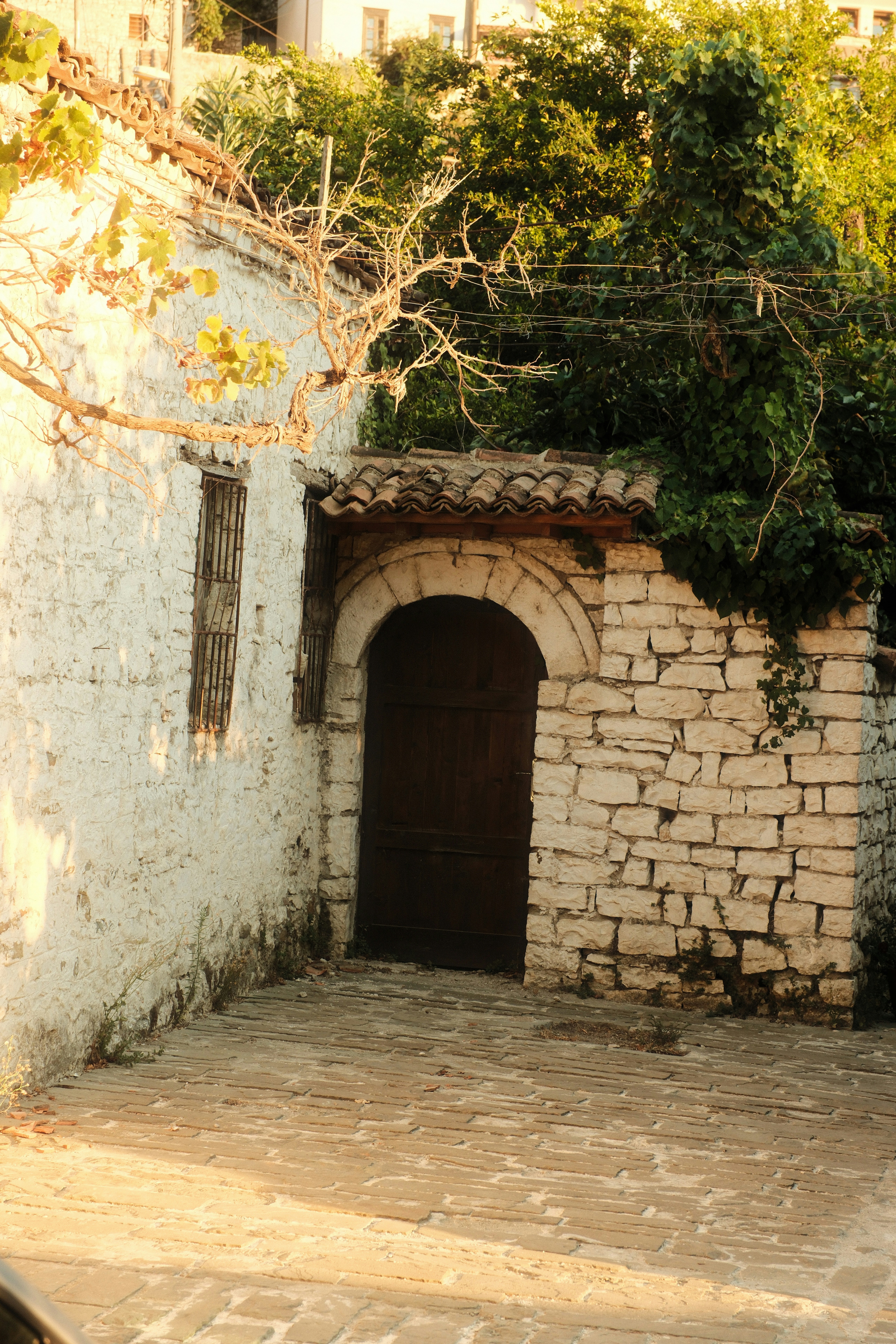 Archway Doorway in Sunlit Stone Courtyard