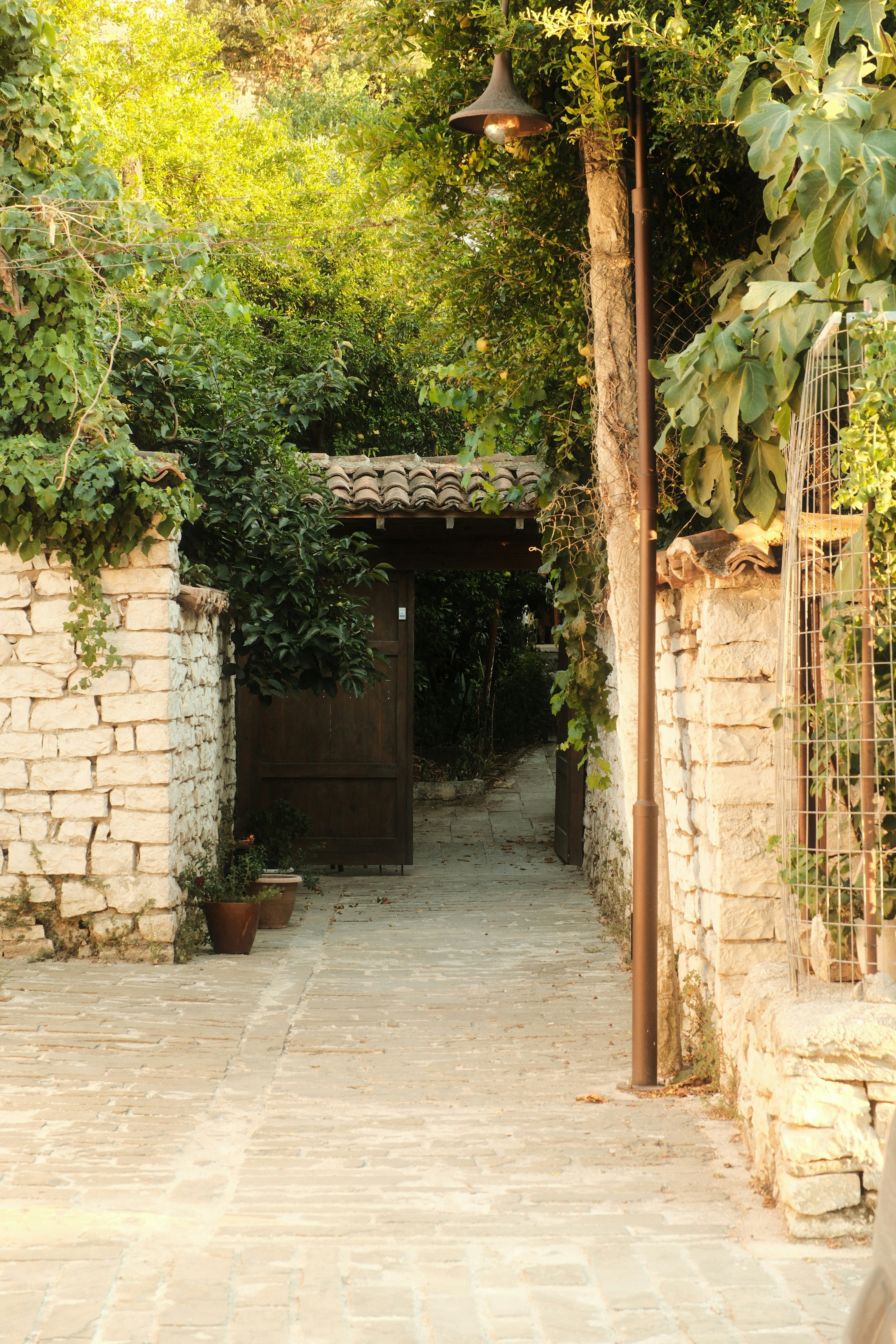 Sunlit Passage Through a Quiet Stone Courtyard