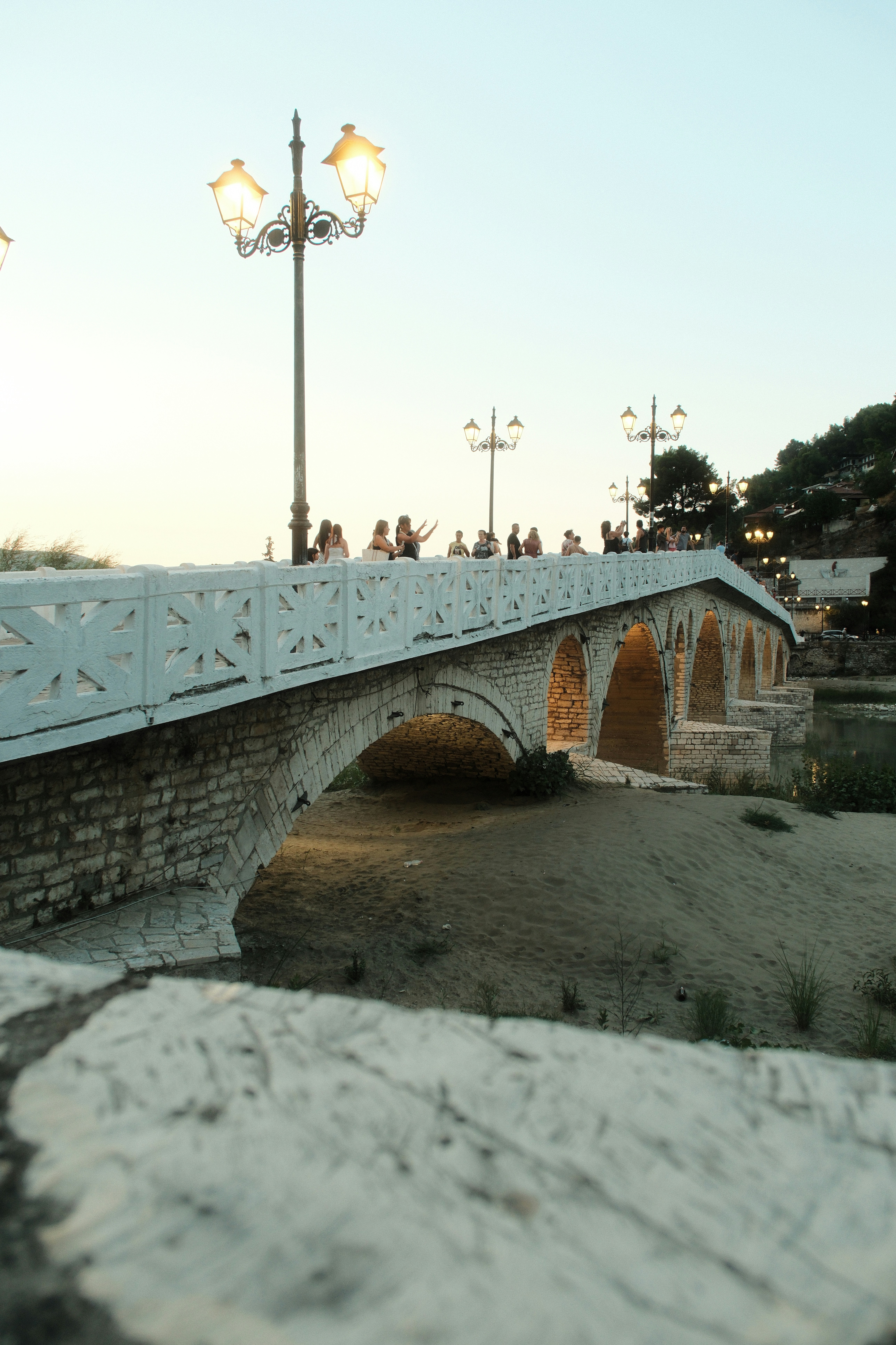 Arched Bridge at Dusk: Lanterns, silhouettes and a gentle river glow