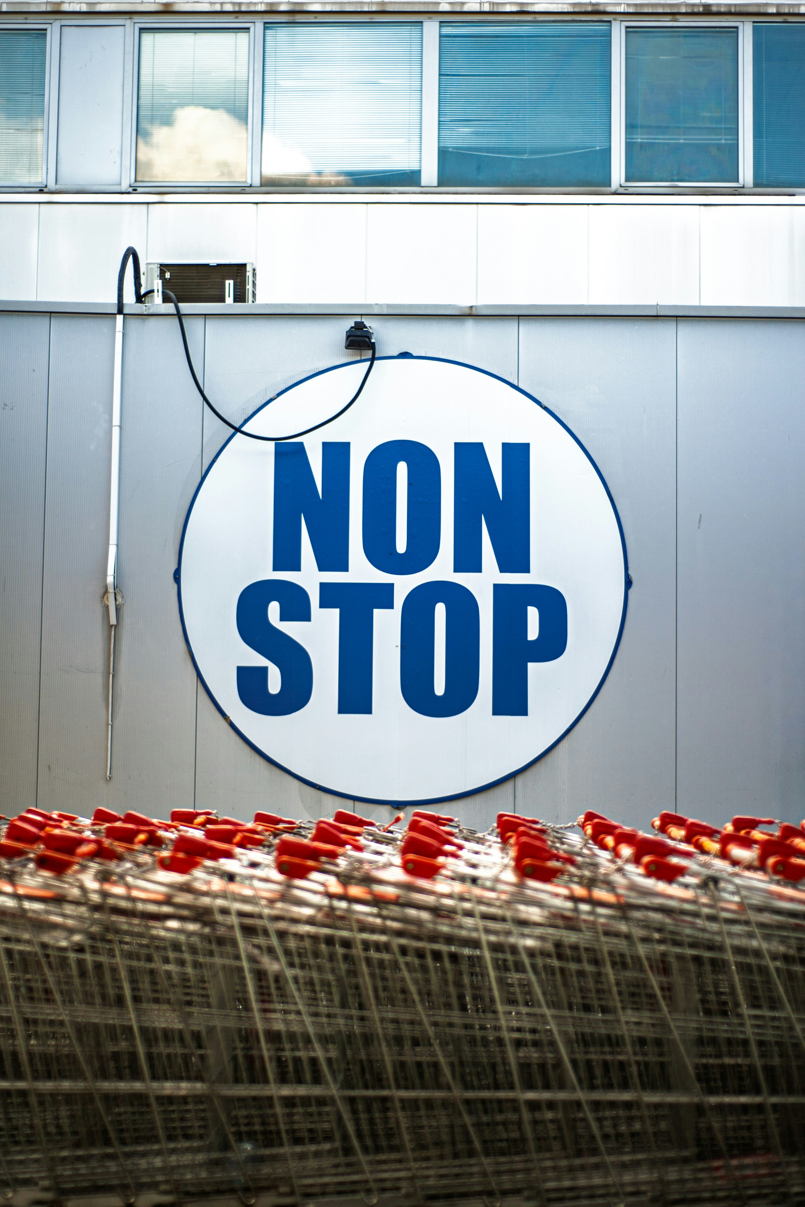 Non Stop Sign: A Circular Bold Statement Against a Sea of Carts