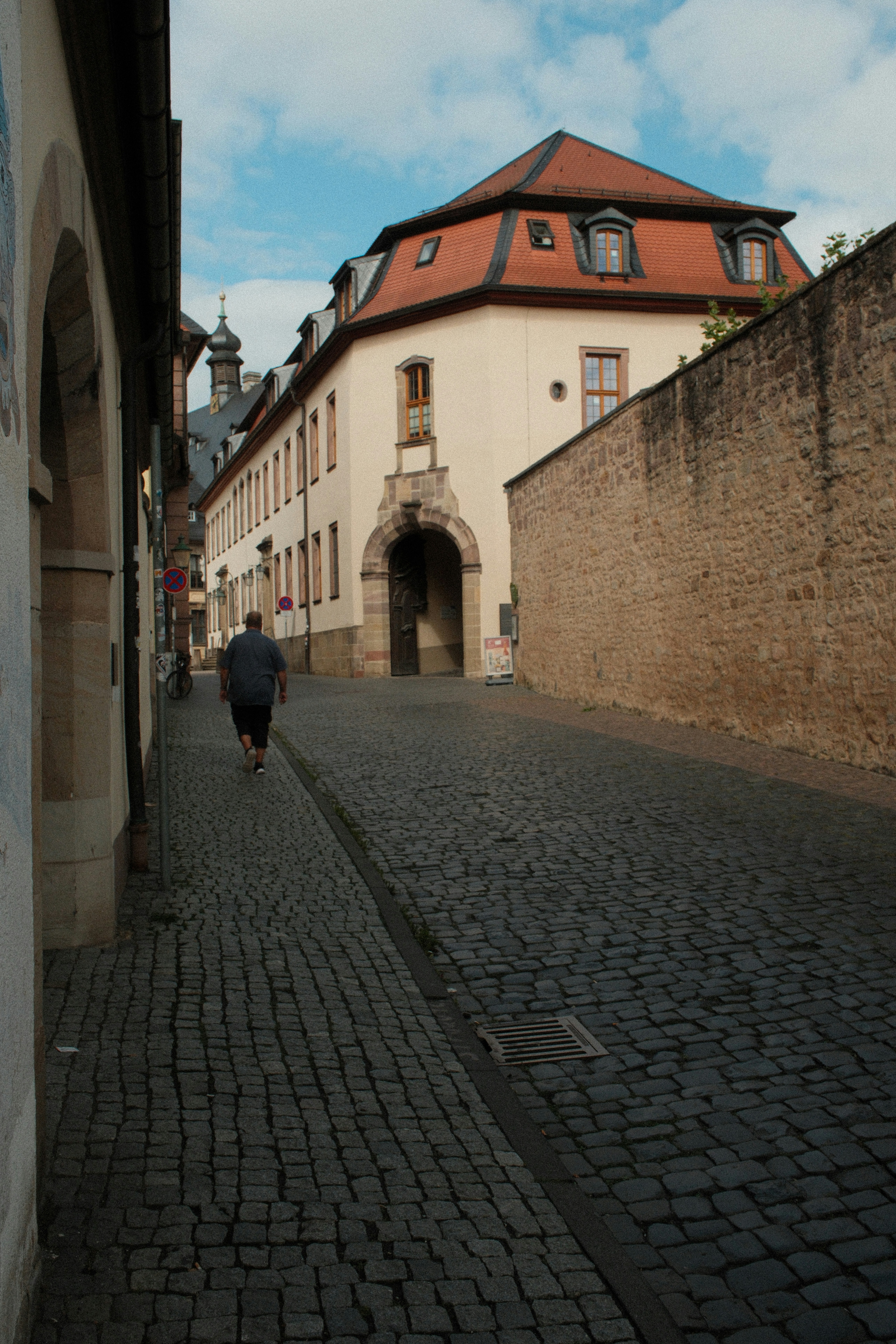 Cobblestone Path to the Gate: A Quiet Quarter Traversed by Footsteps