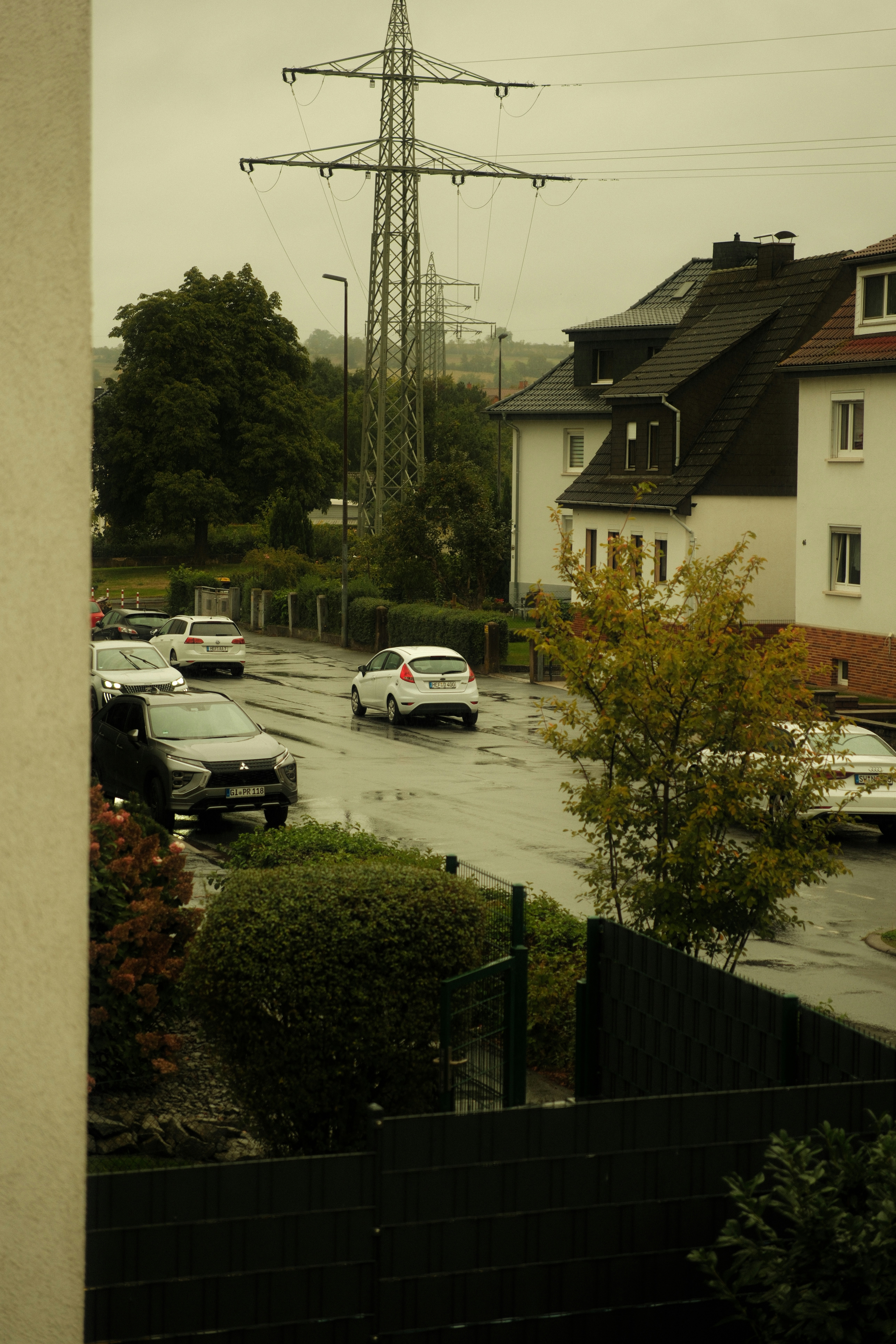 Suburban Street with Overcast Sky and Utility Tower