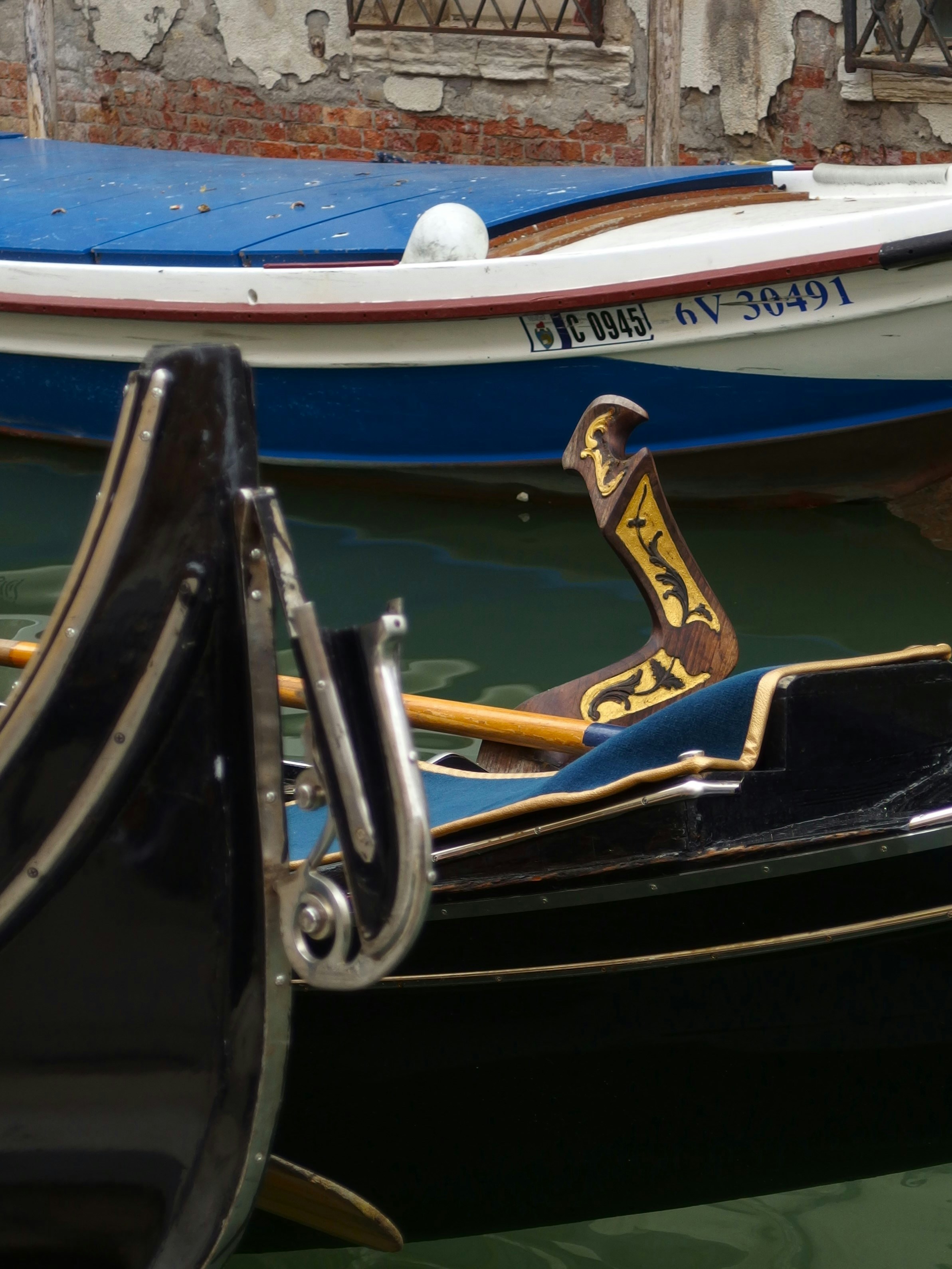 Venetian Gondolas Rest by the Canal