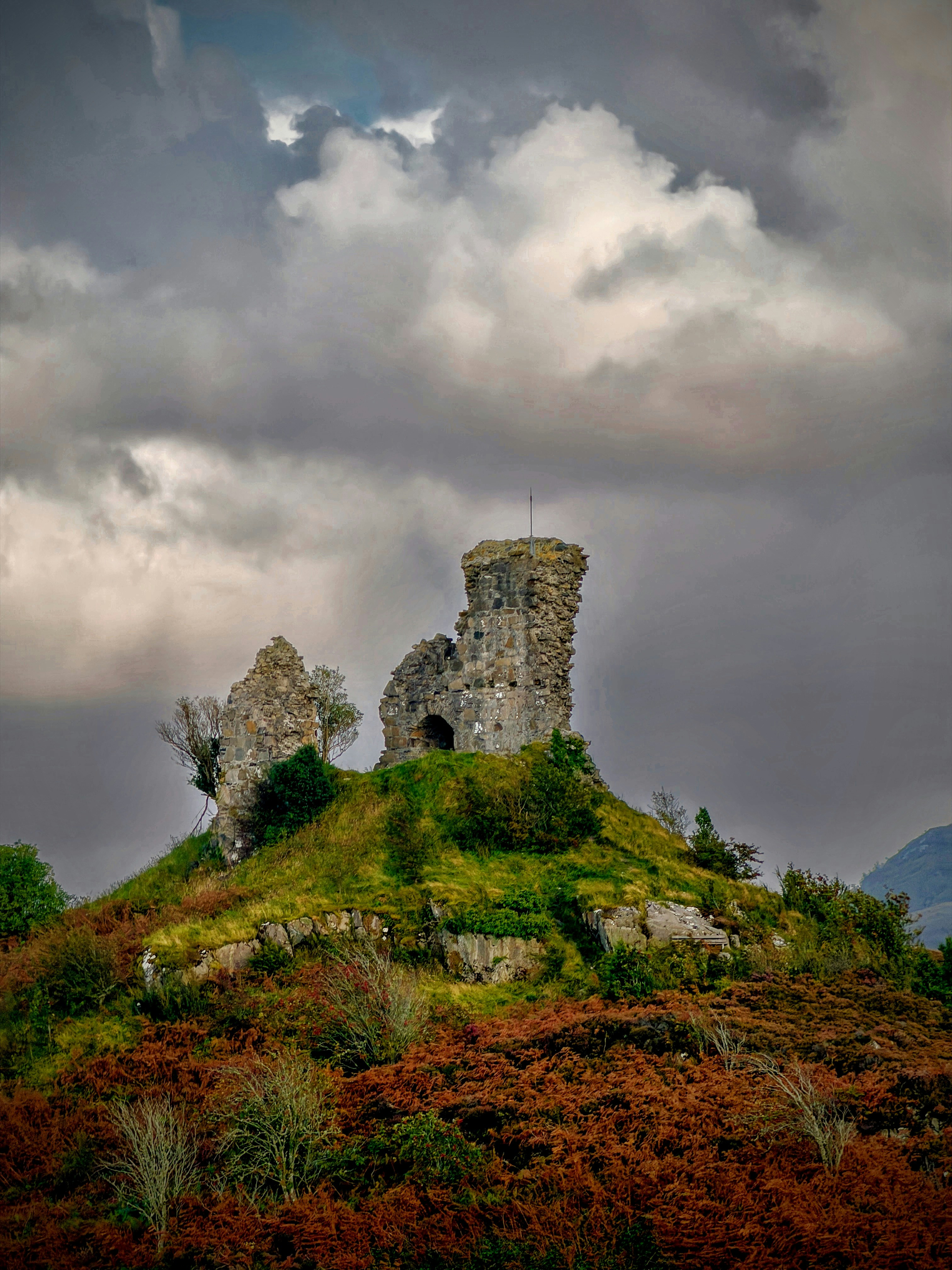 Ruined Turret on a Crowned Hill Under Looming Clouds