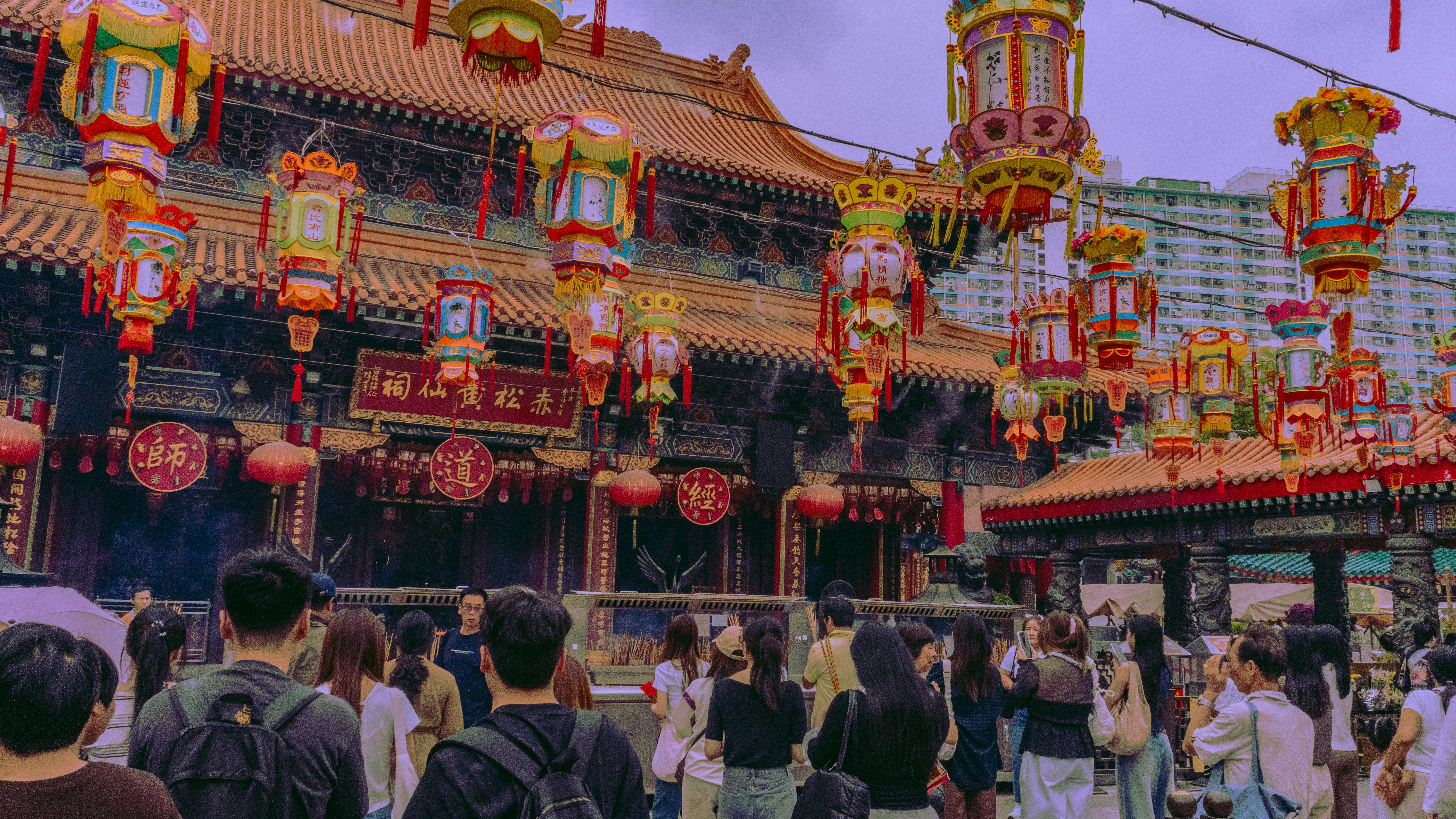 Lanterns and laughter under a festival sky at the temple gate