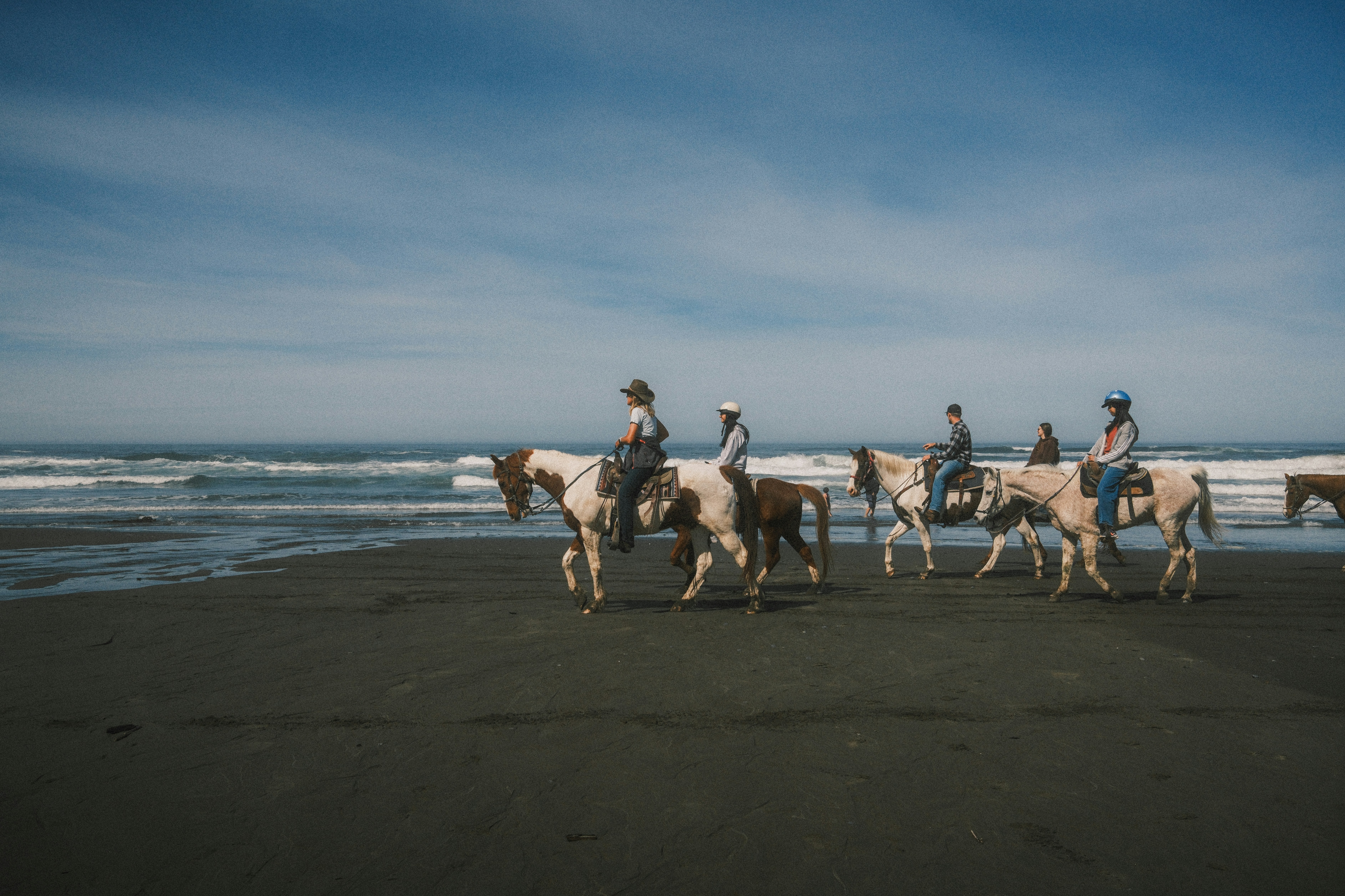 Trail of Riders along a Pacific Shore