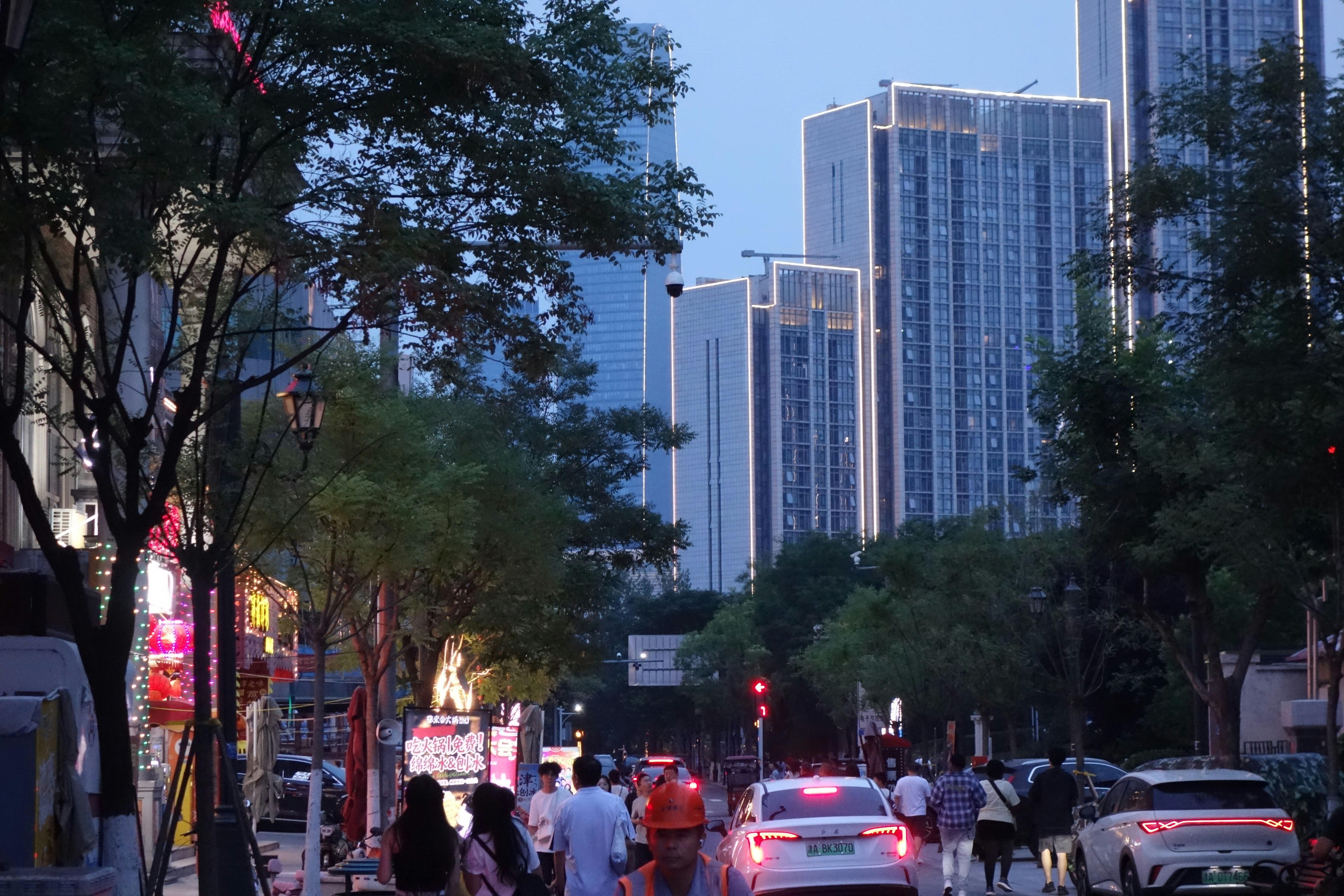 Urban Pulse: Nighttime Street with Neon and Skyscrapers