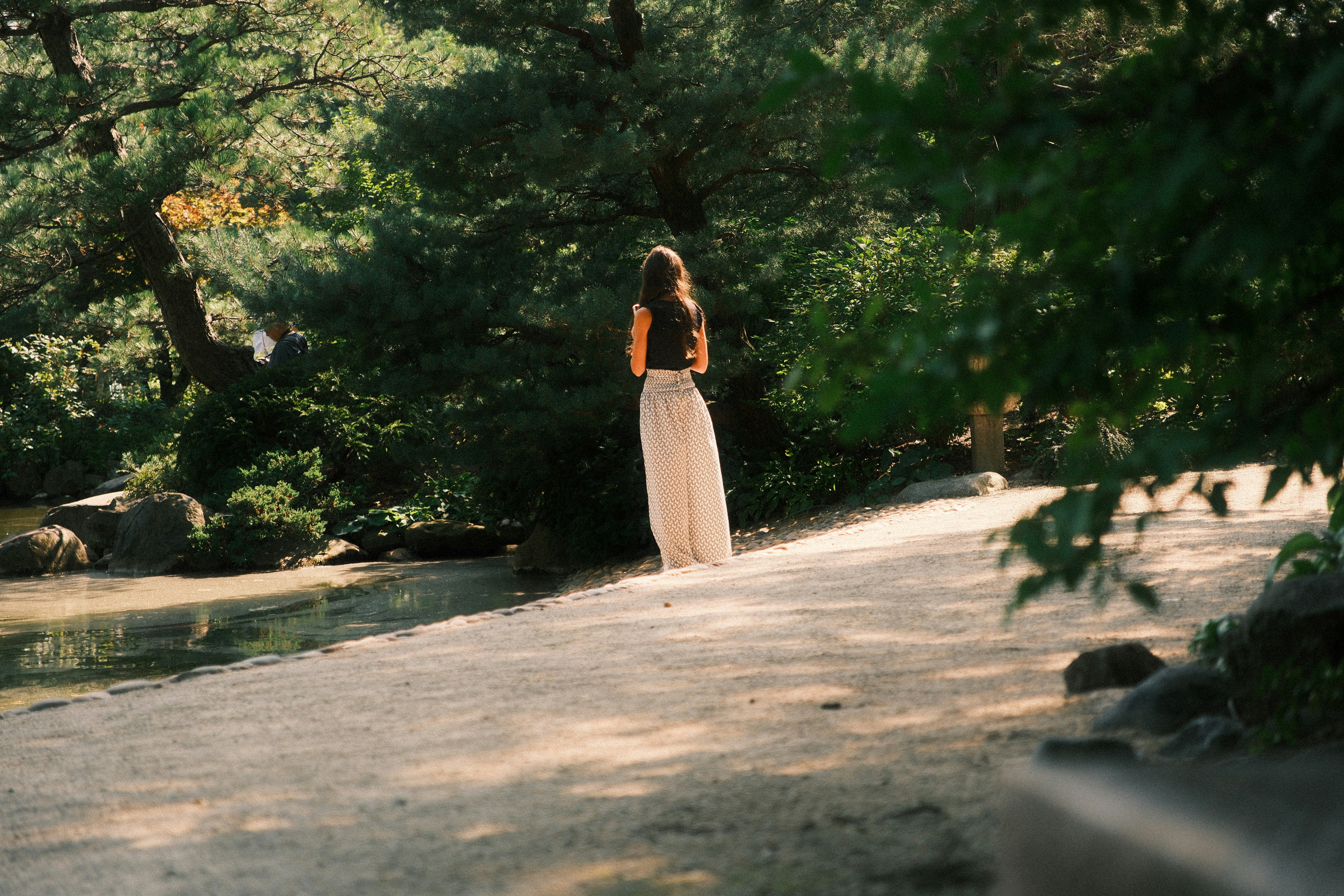 Solitary Figure by the Riverside Canopy