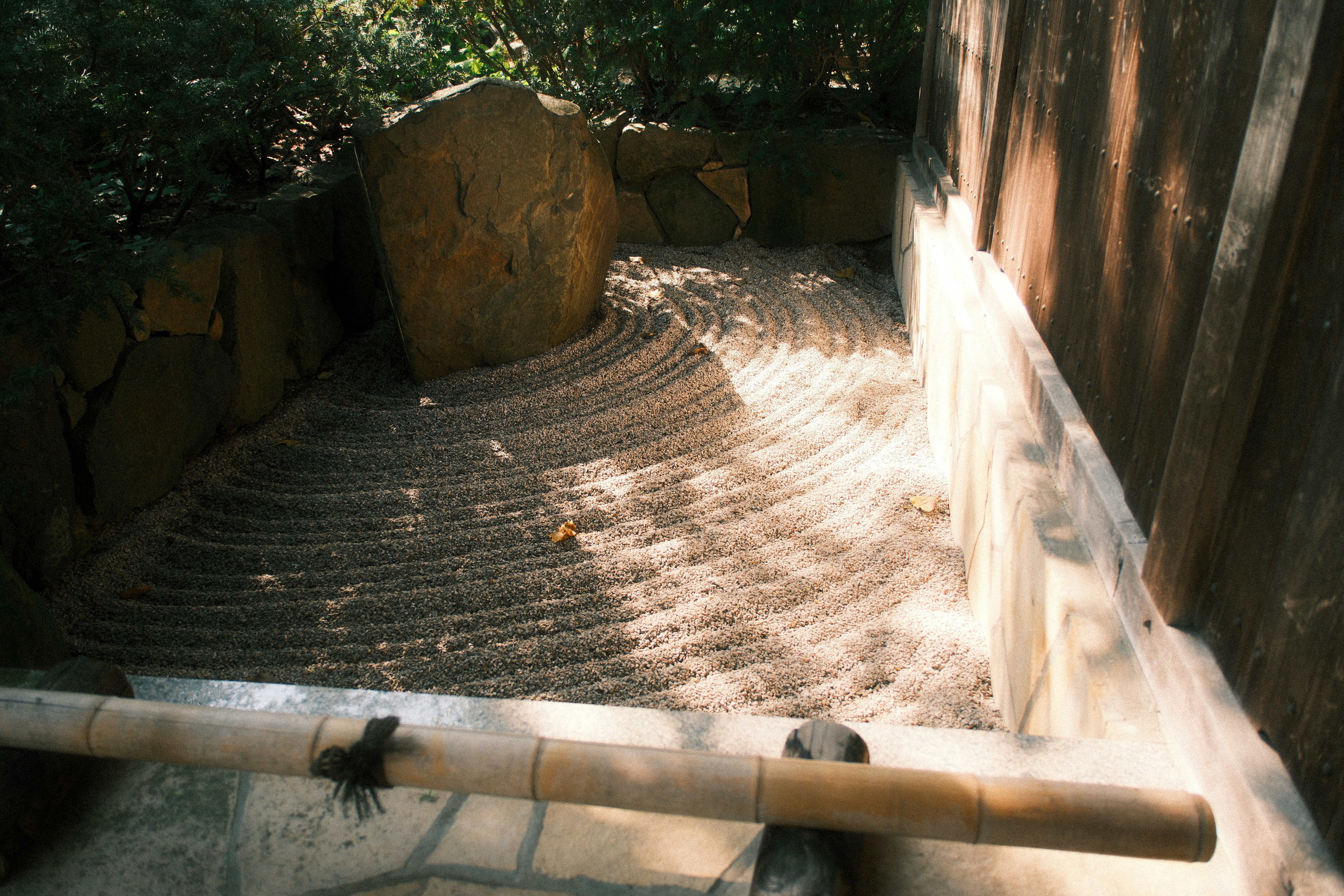 Zen Gravel Garden: Raked Circles by the Stone Wall