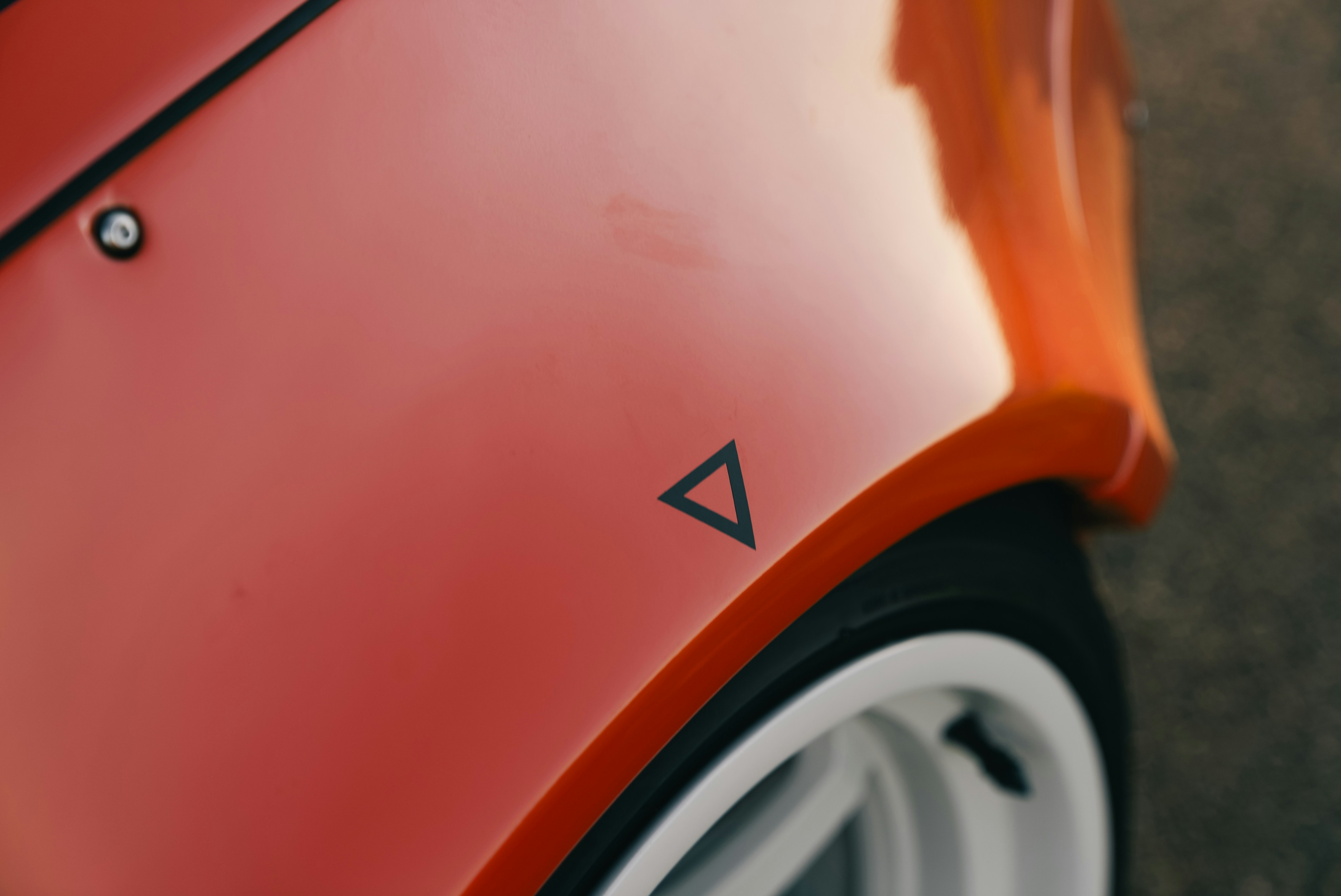 Rustic Orange Curve: A Car’s Quiet Geometry