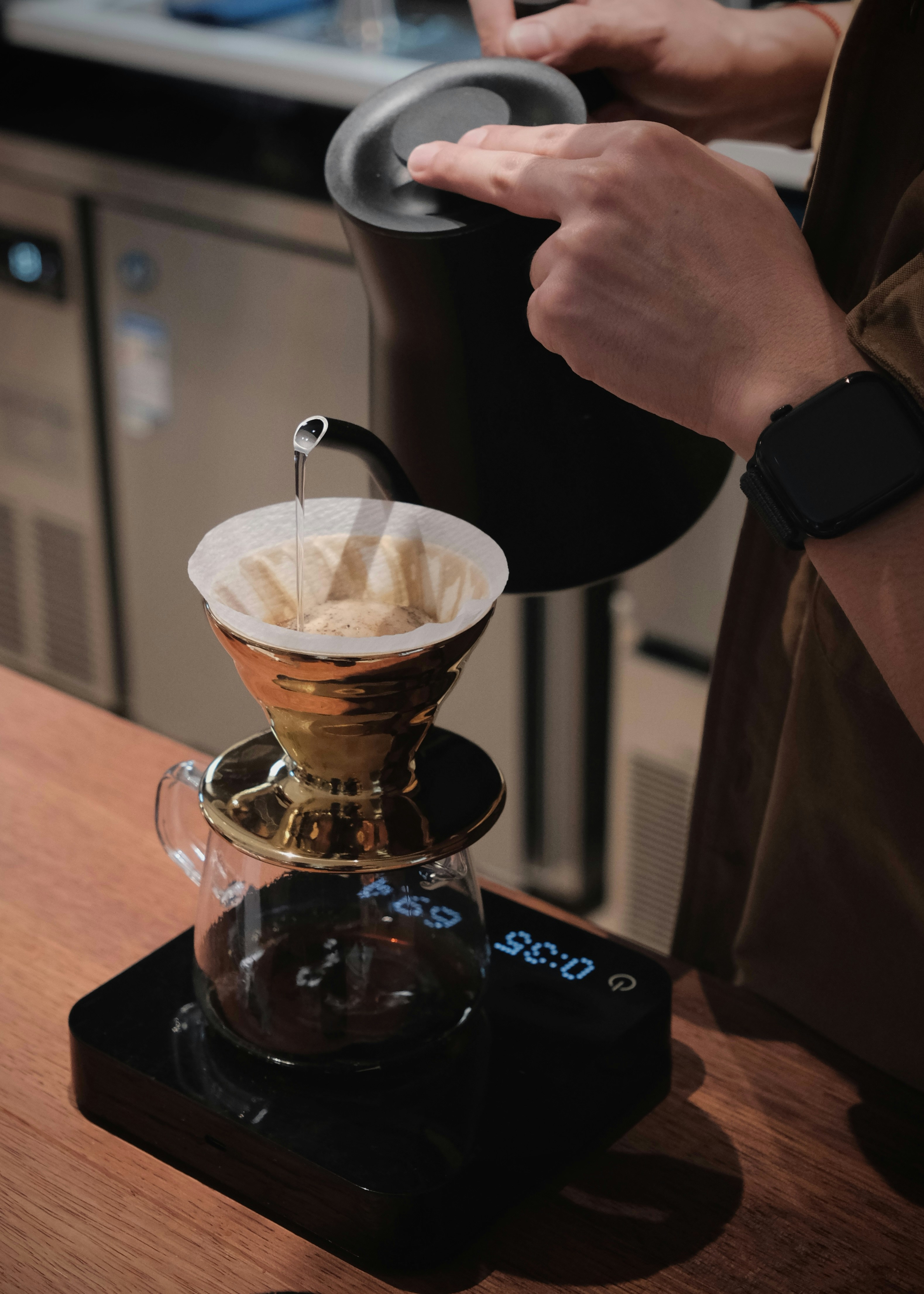 Pour-Over Precision: Hand and Kettle at the Drip Station