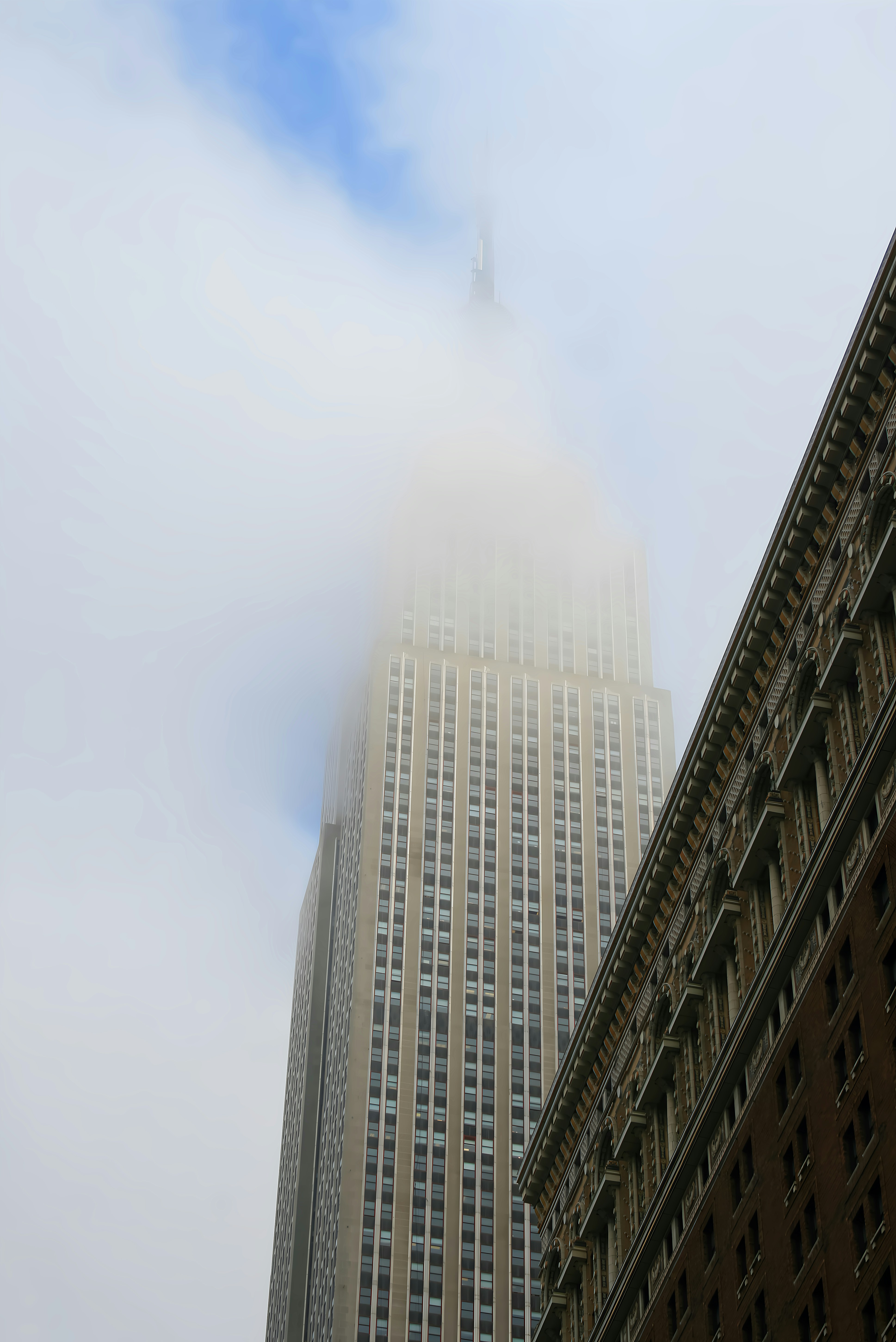 Tower in the Clouds: Empire State Shrouded by Morning Fog