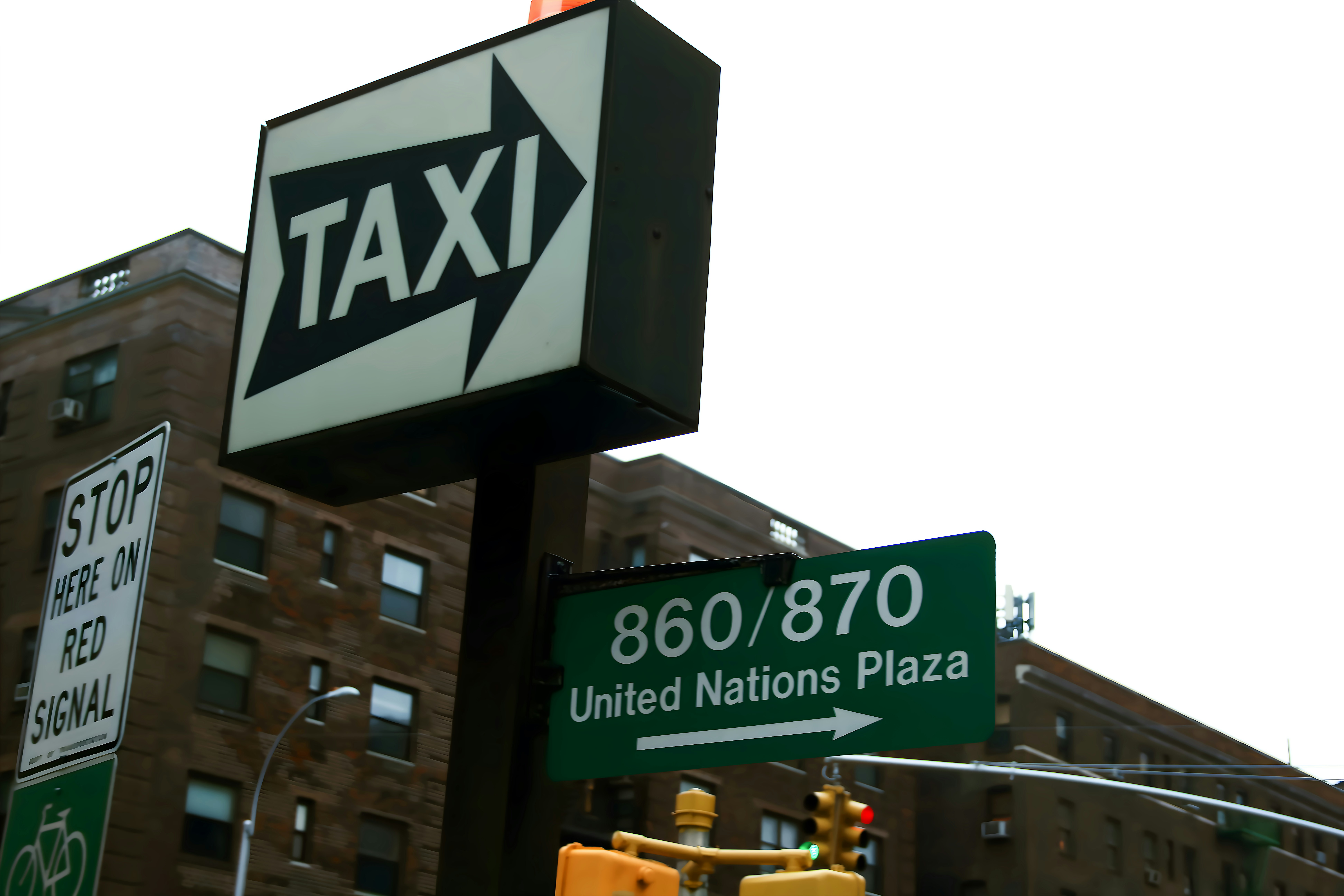 Taxi Sign Over Urban Crossroads at United Nations Plaza