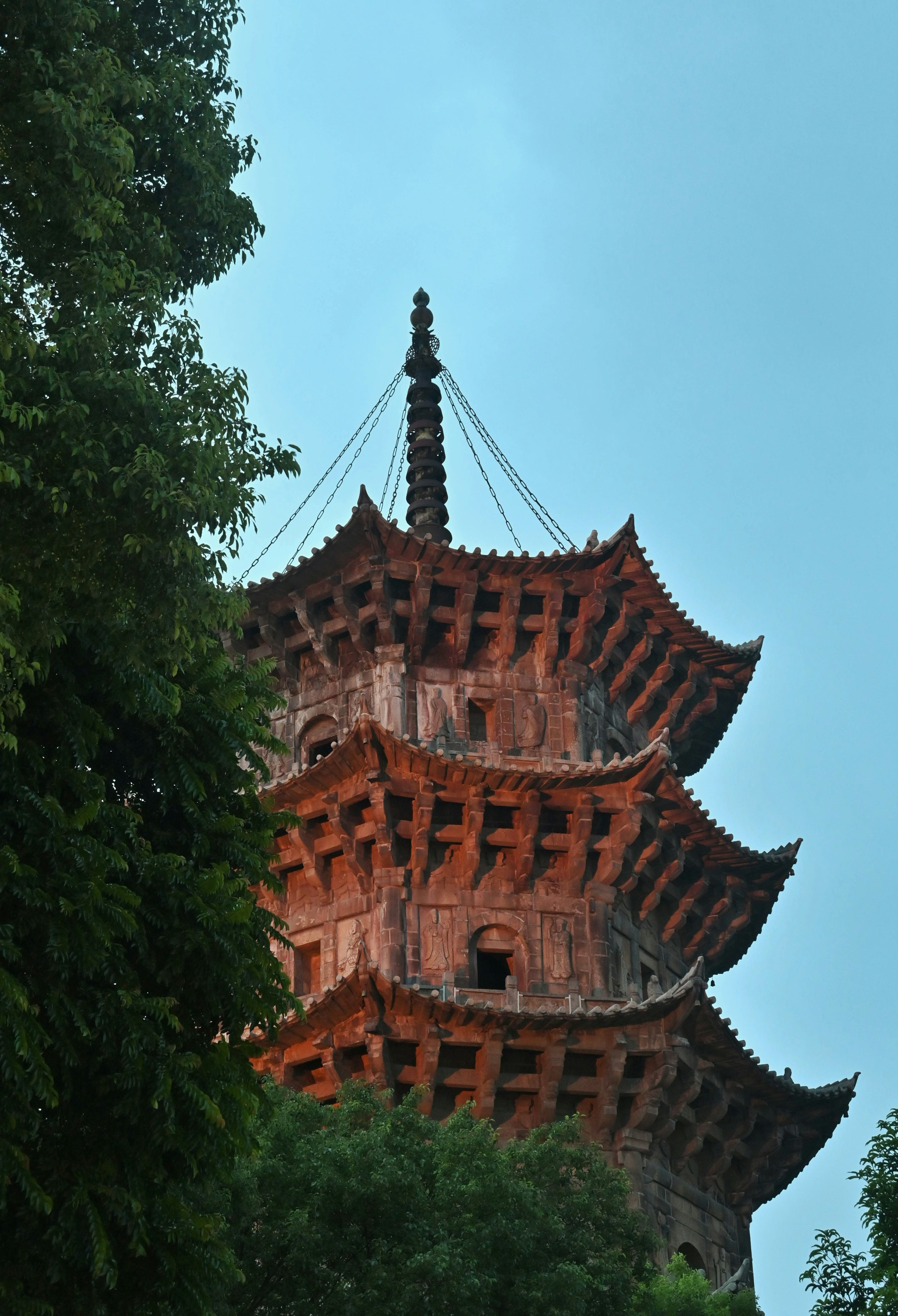 Red-brick Pagoda Rising Beyond the Green Canopy