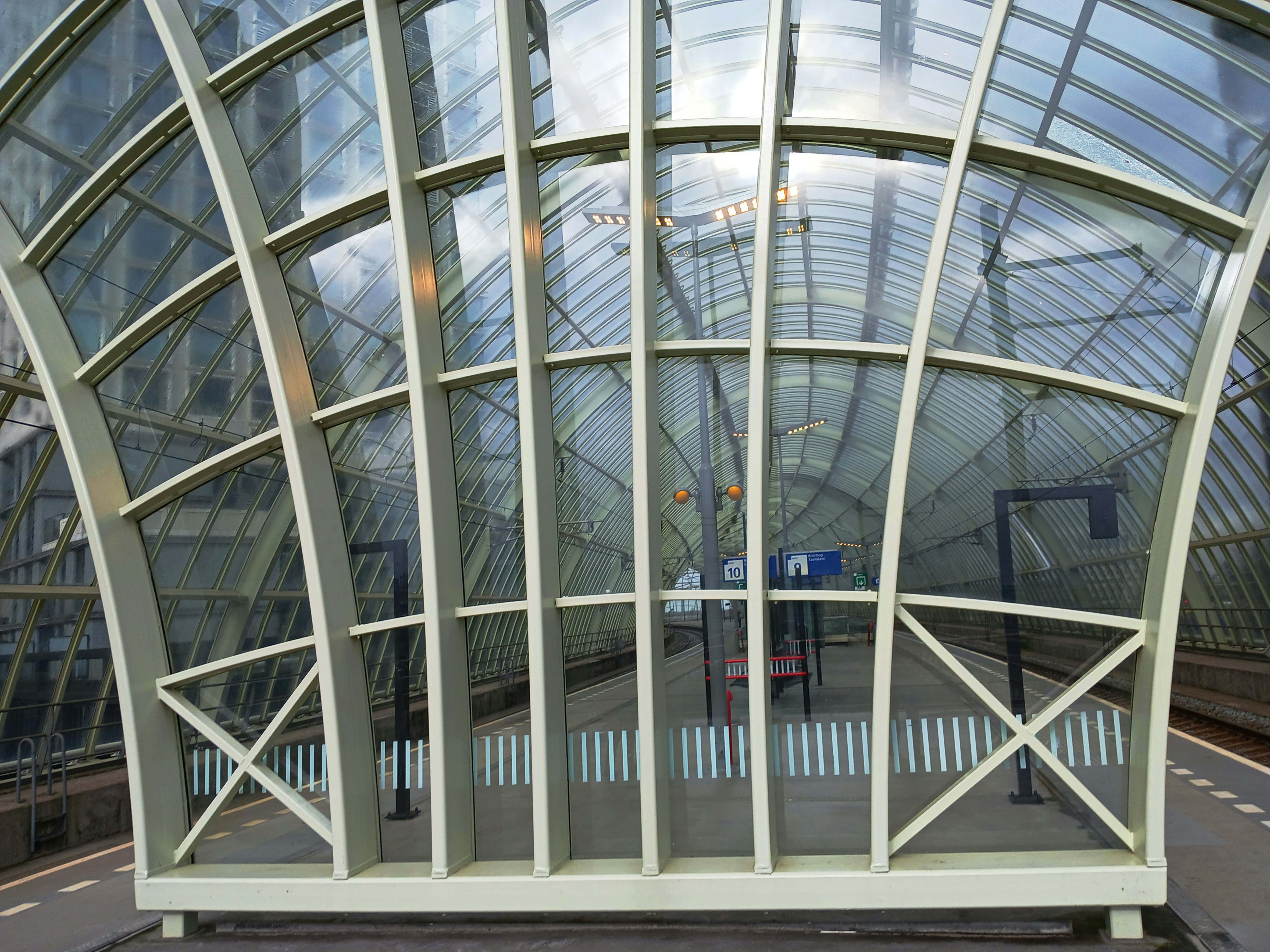 Cobalt Archway: Light-filled Glass Corridor