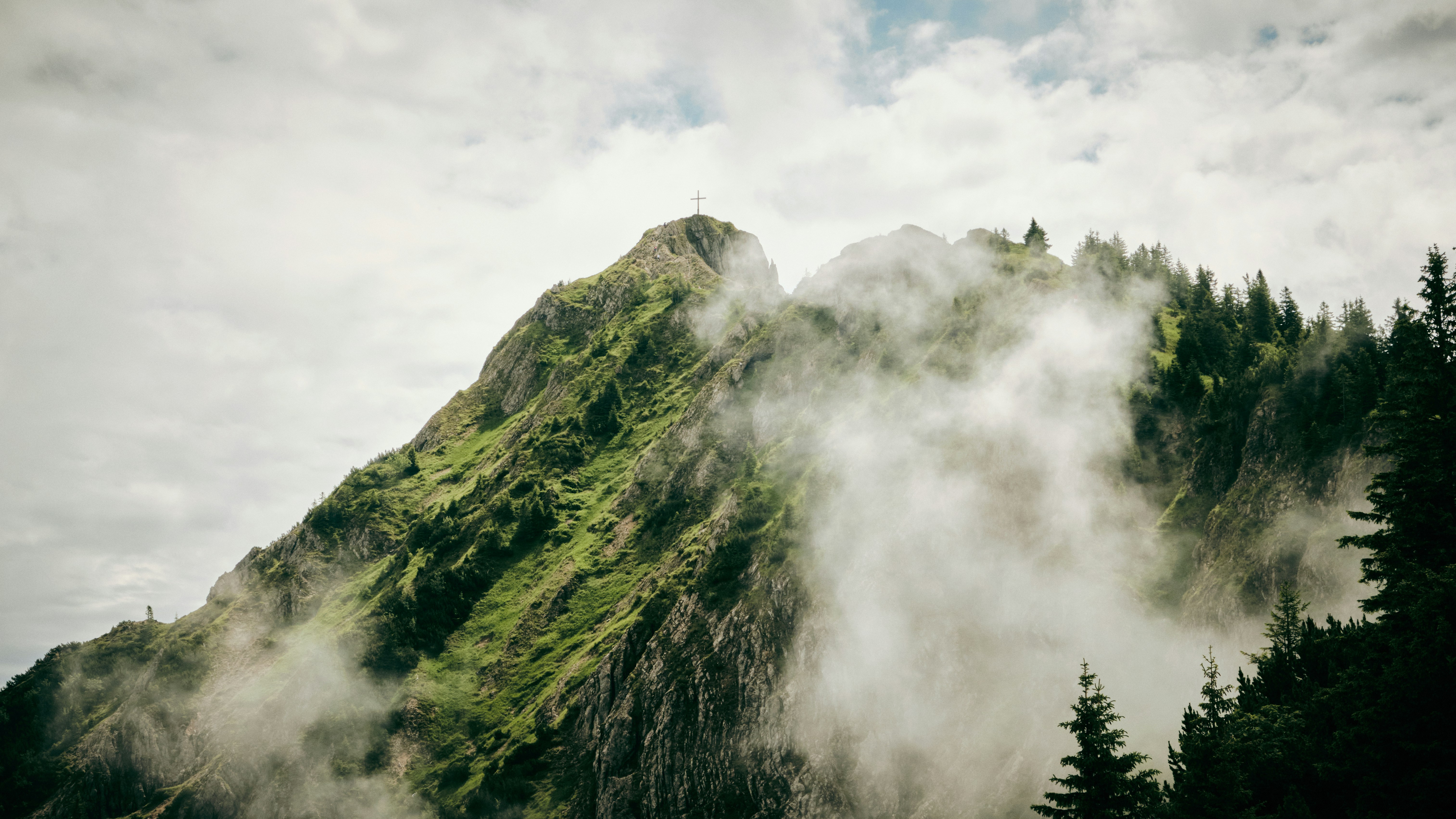 Cross atop the Misty Peak: A Summit in Green Quiet