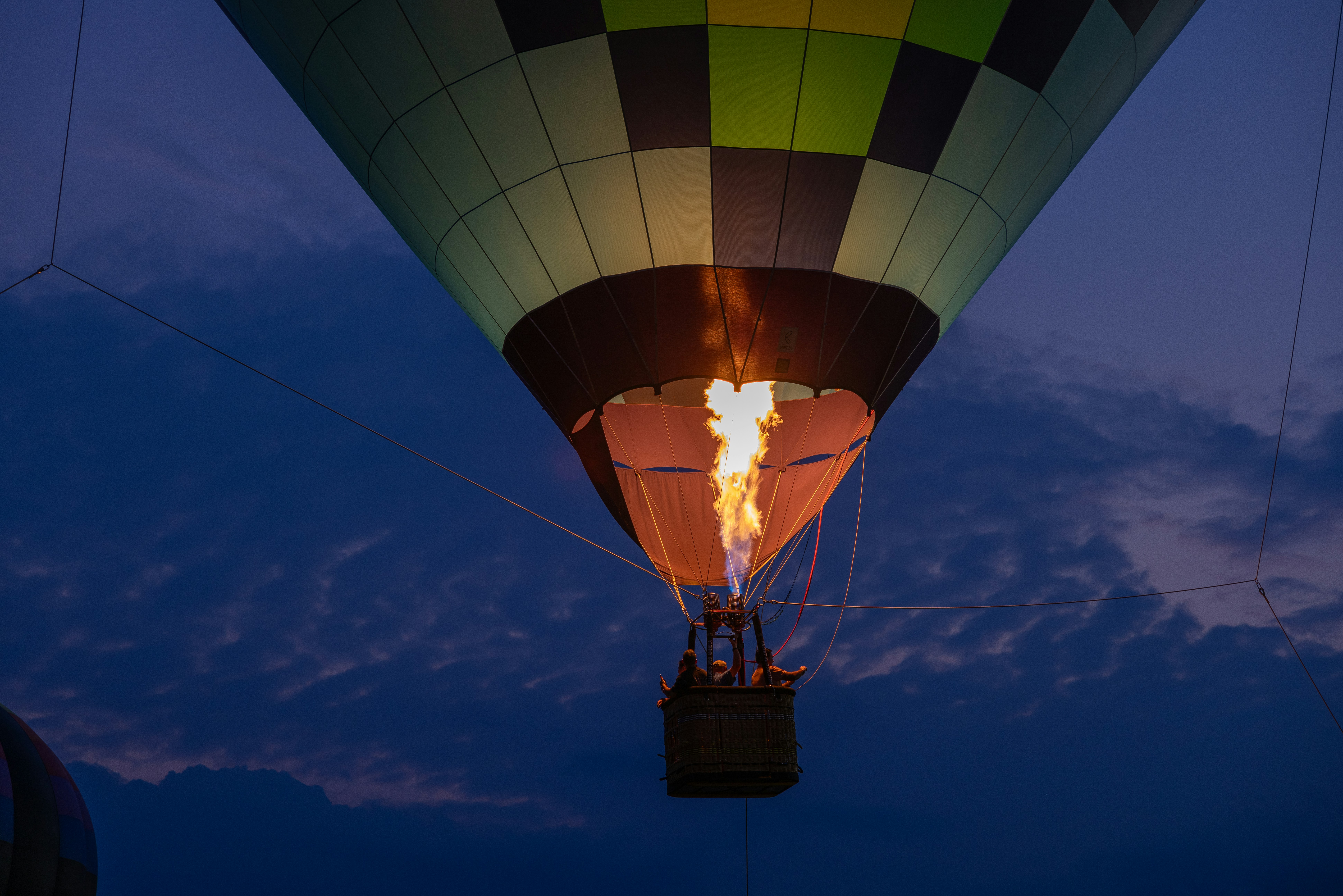 Midair Flame: A Neon-Tinted Balloon Ascends at Twilight