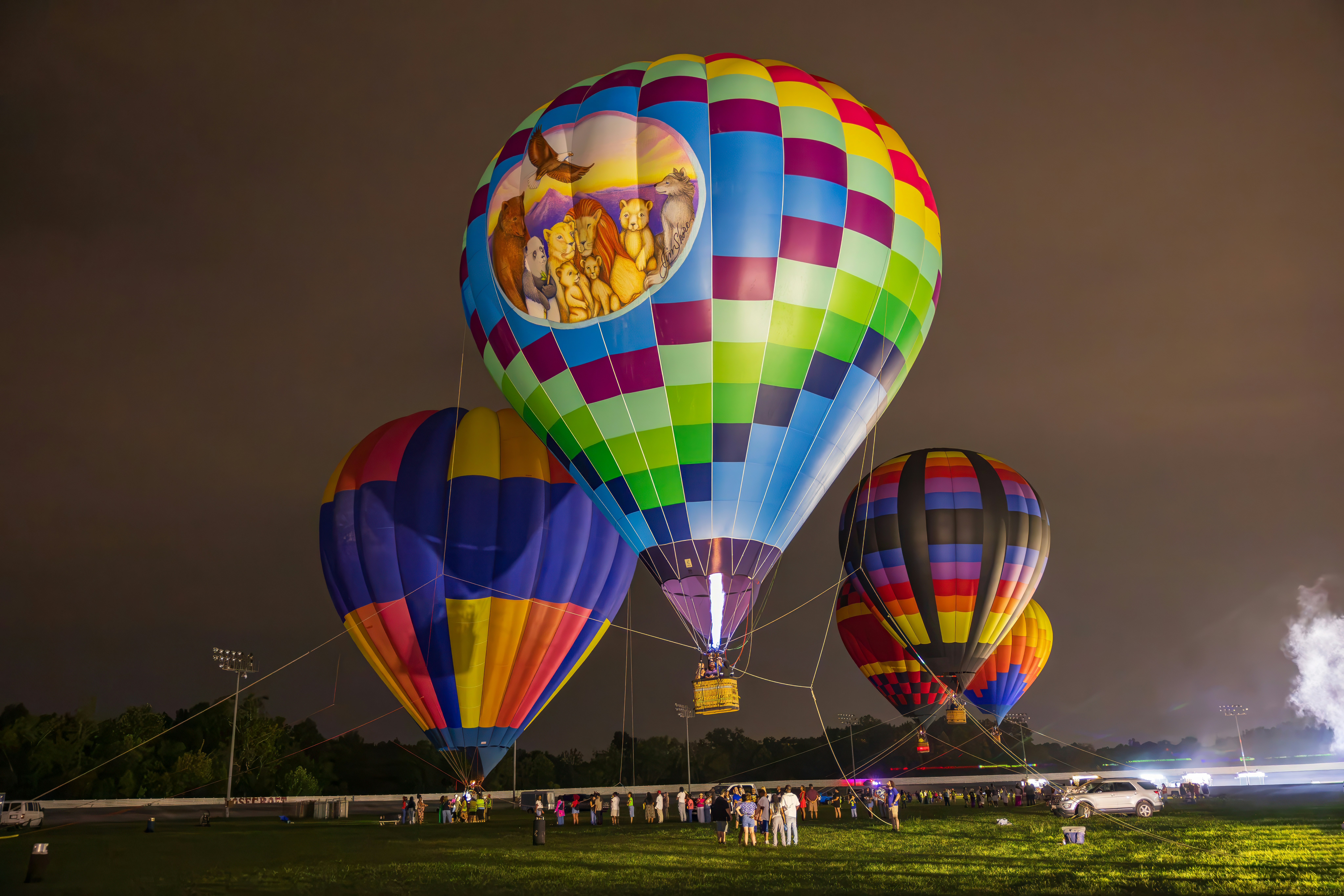 Colorful ascent: a night-time hot air balloon festival under warm glow