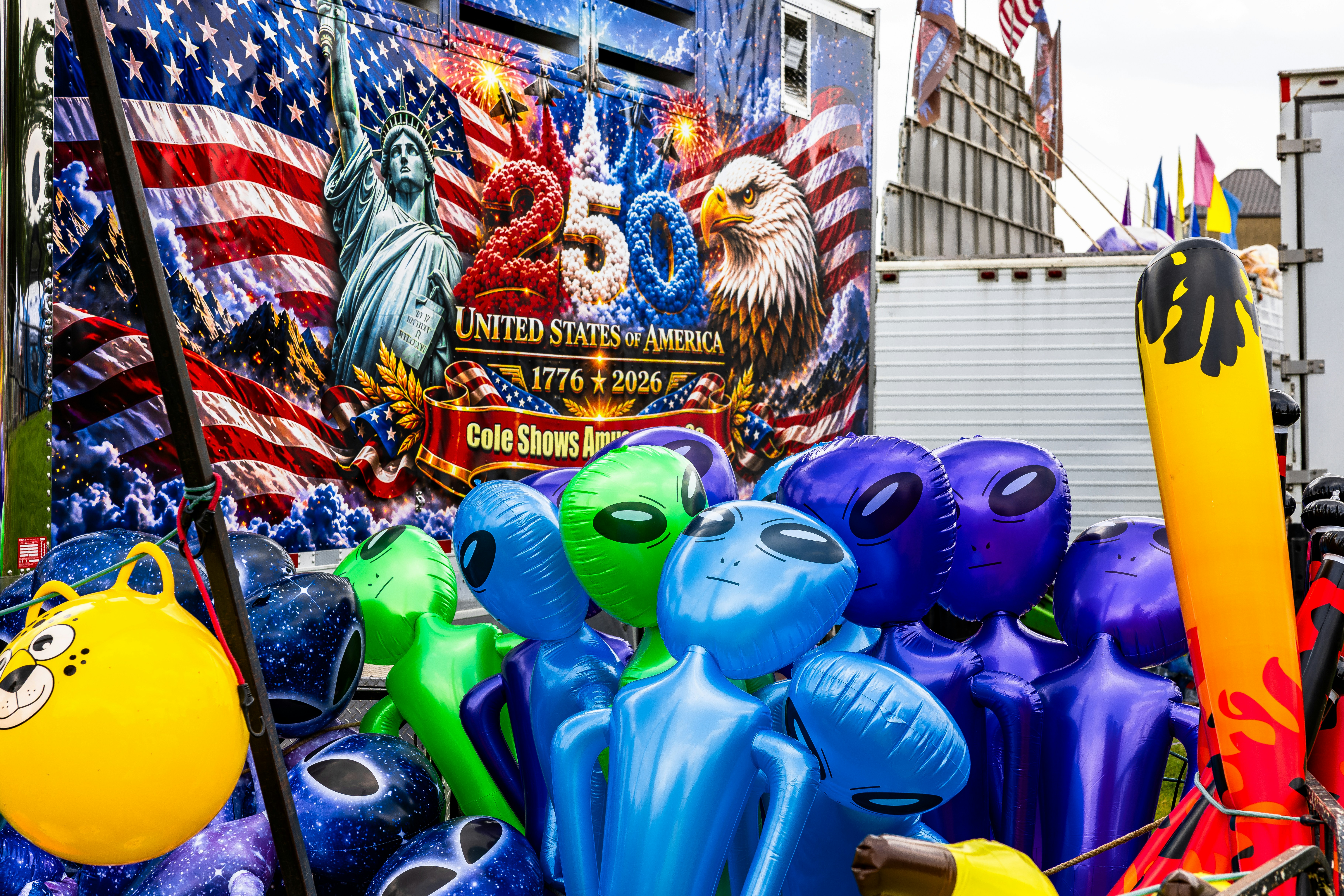 Patriotic Floats and Colorful Balloons at a Festival Booth