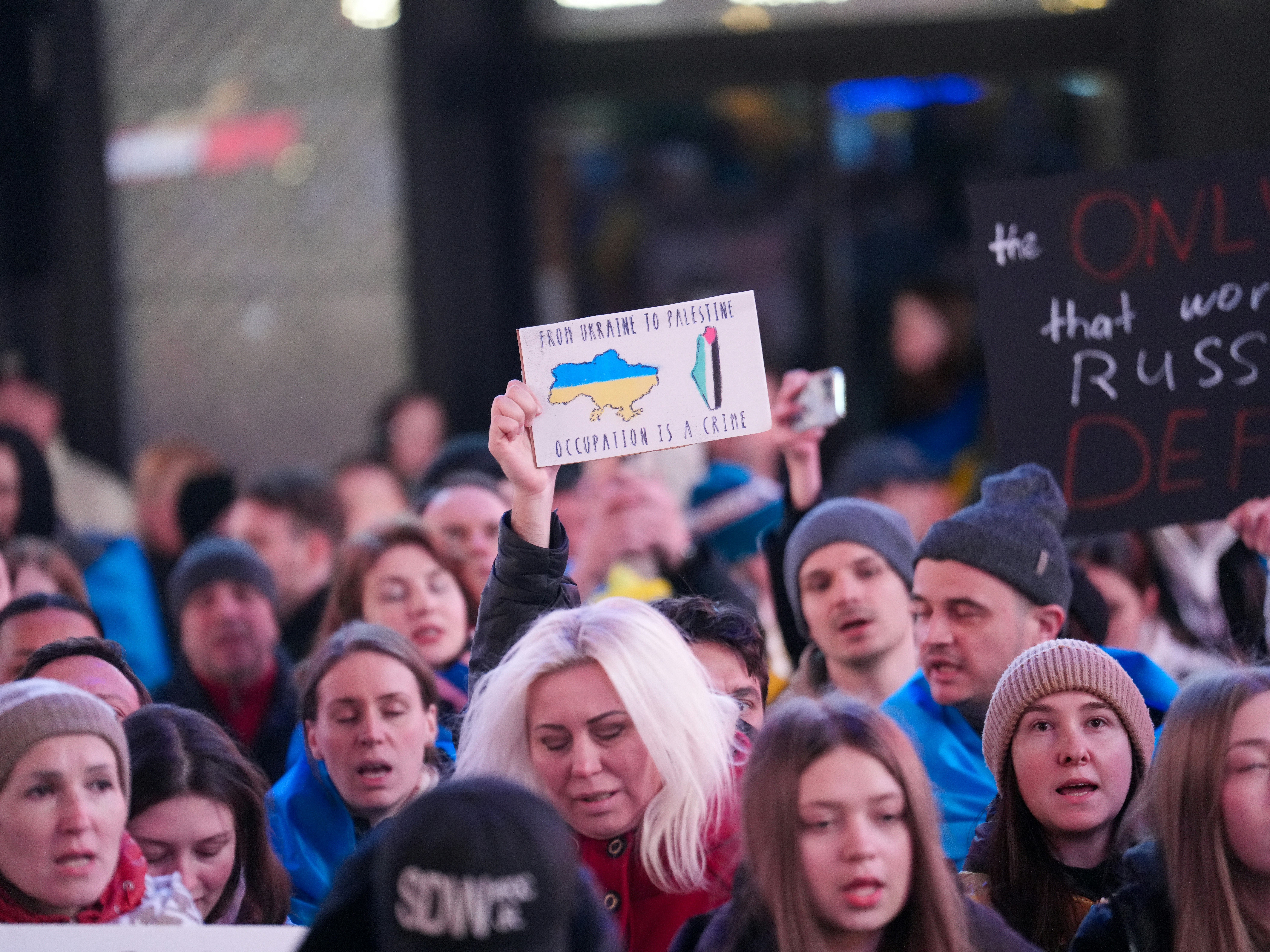 Hands Up for Change: A Protest Crowd Banners the Message