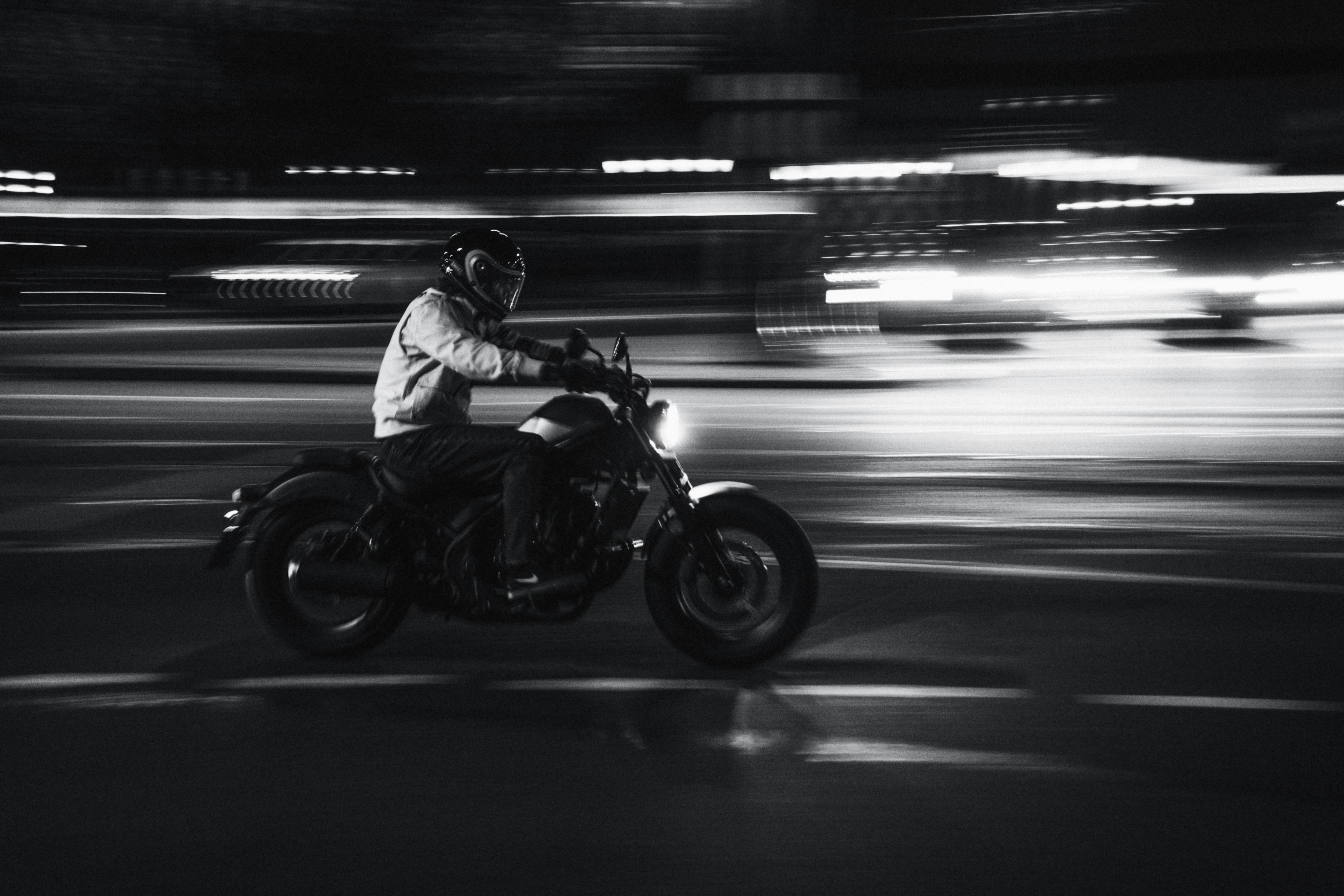 Midnight Ride: A lone motorcyclist Surges Through City Lights