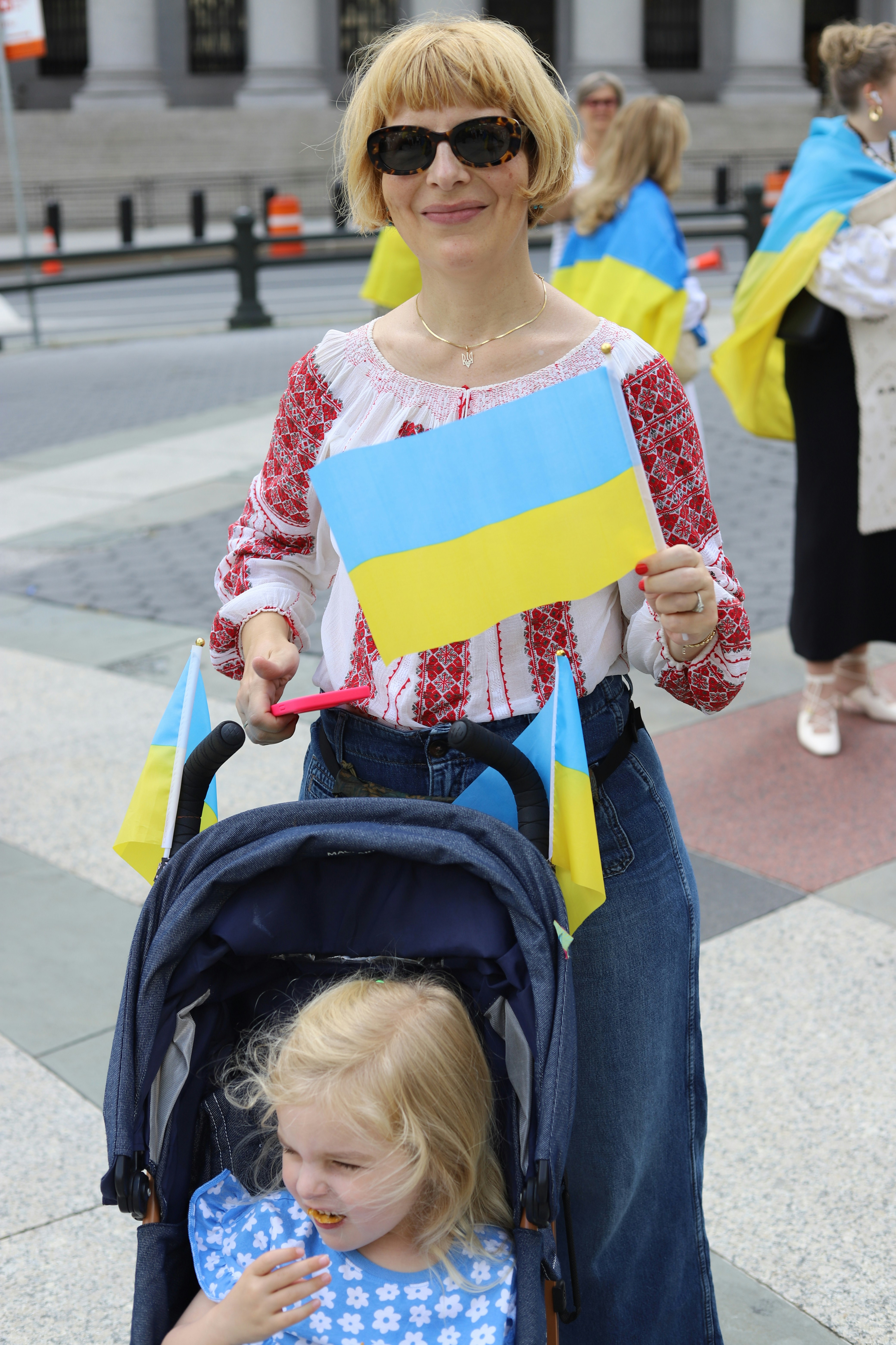 Bright Flag, Brighter Smile: A Mother and Child at a Unity Parade