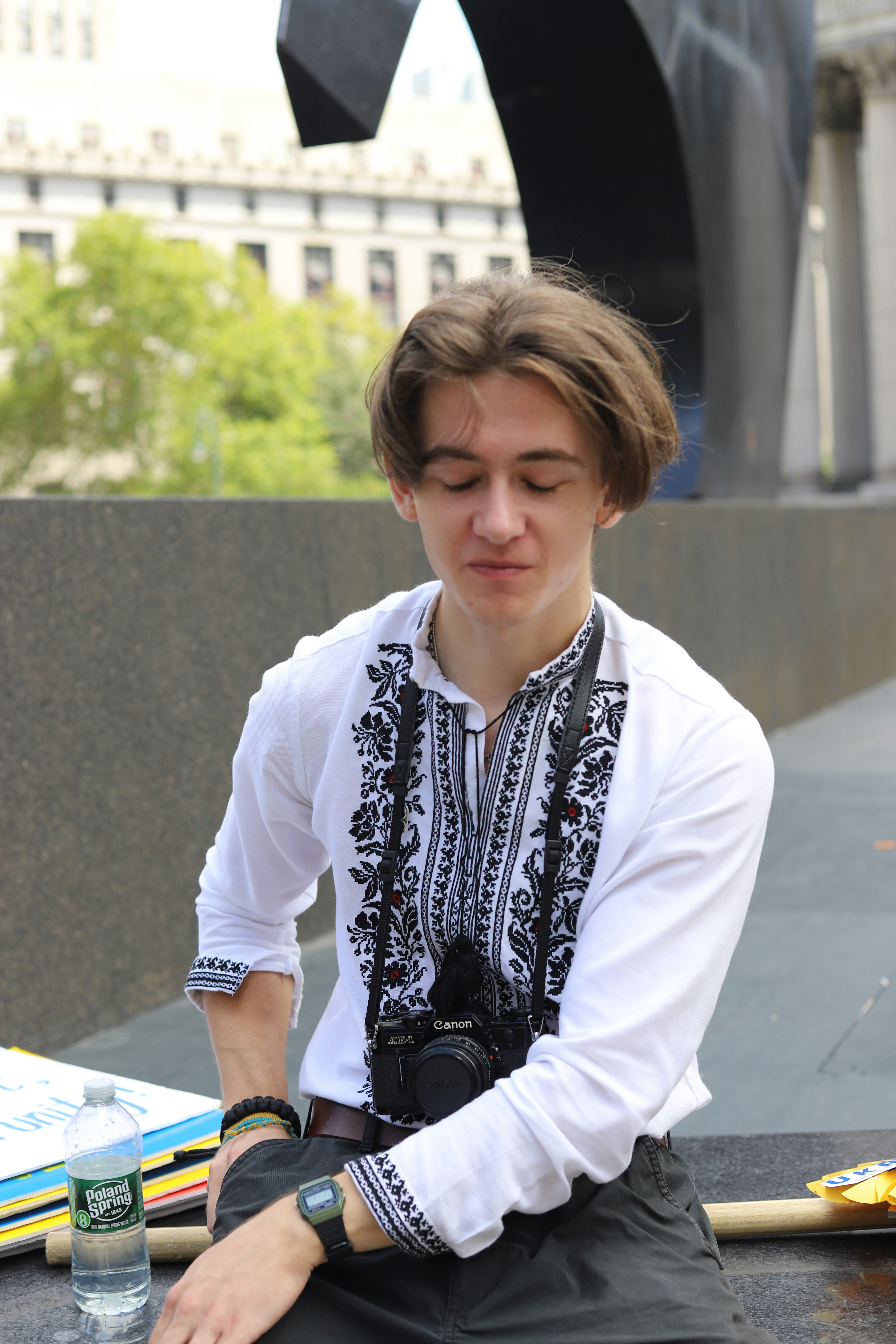 Portrait in a White Patterned Shirt: A Moment Relaxed by the River