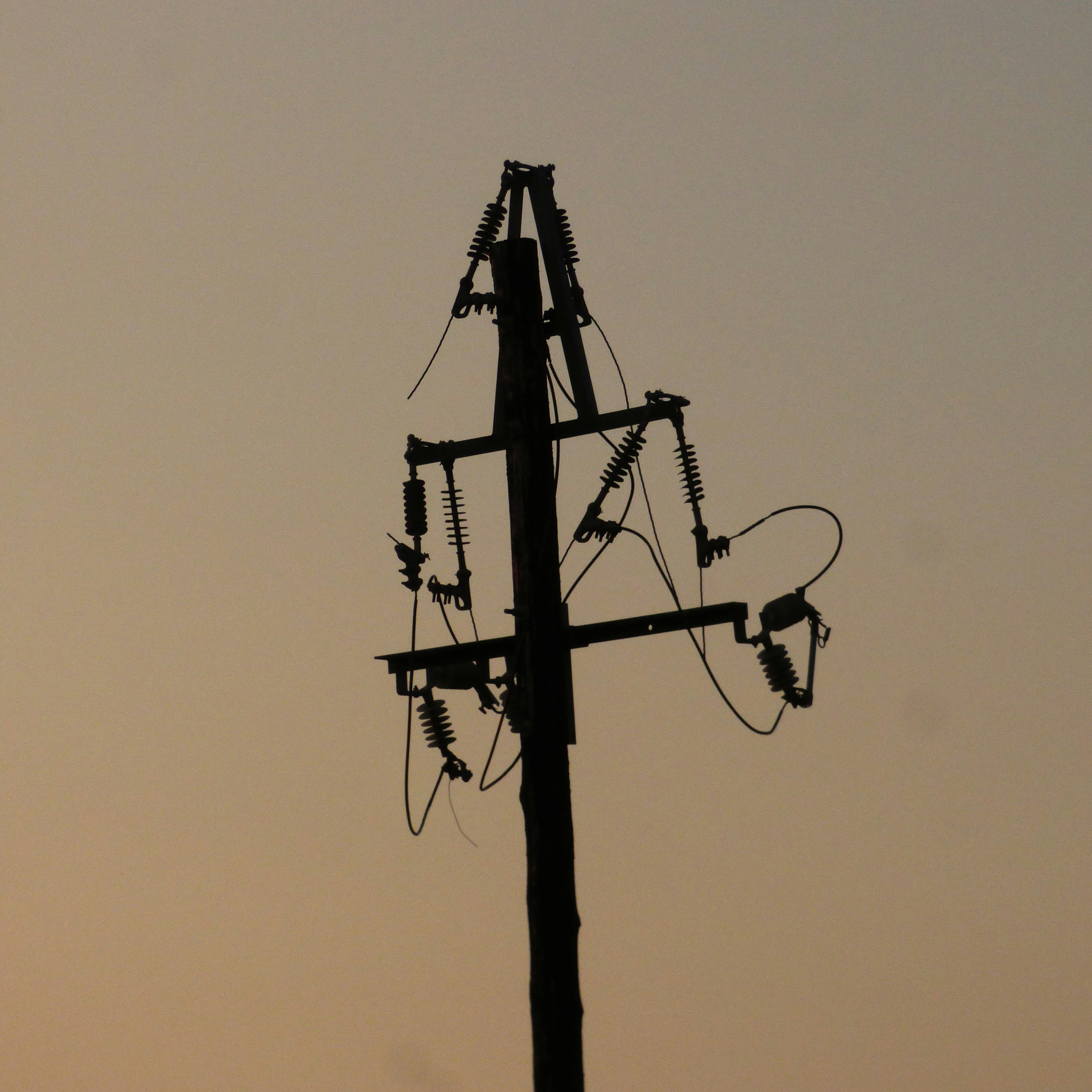 Silhouette of a Power Cross Stemming from a Golden Dusk