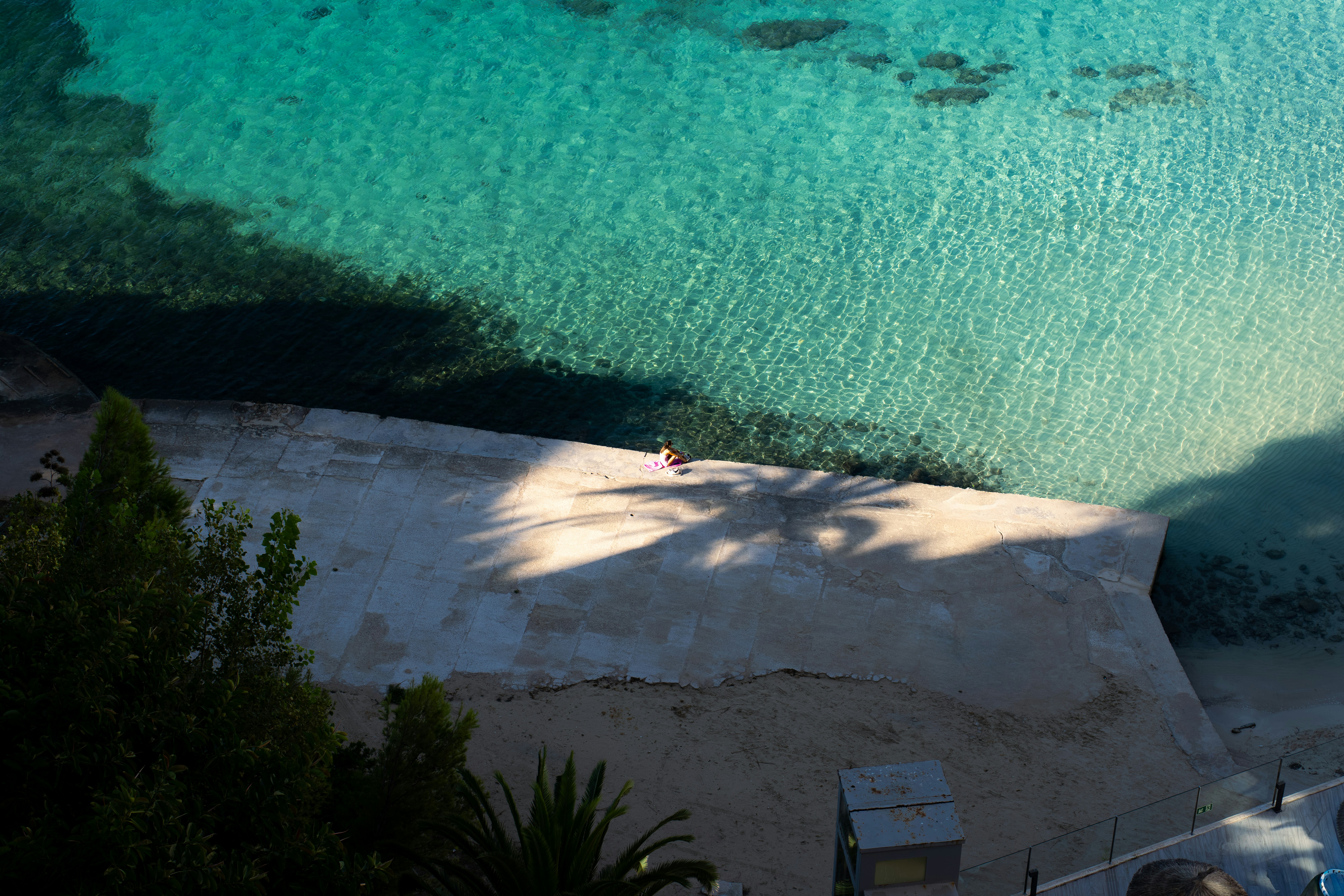 Solitary Silhouette Amid Turquoise Tide
