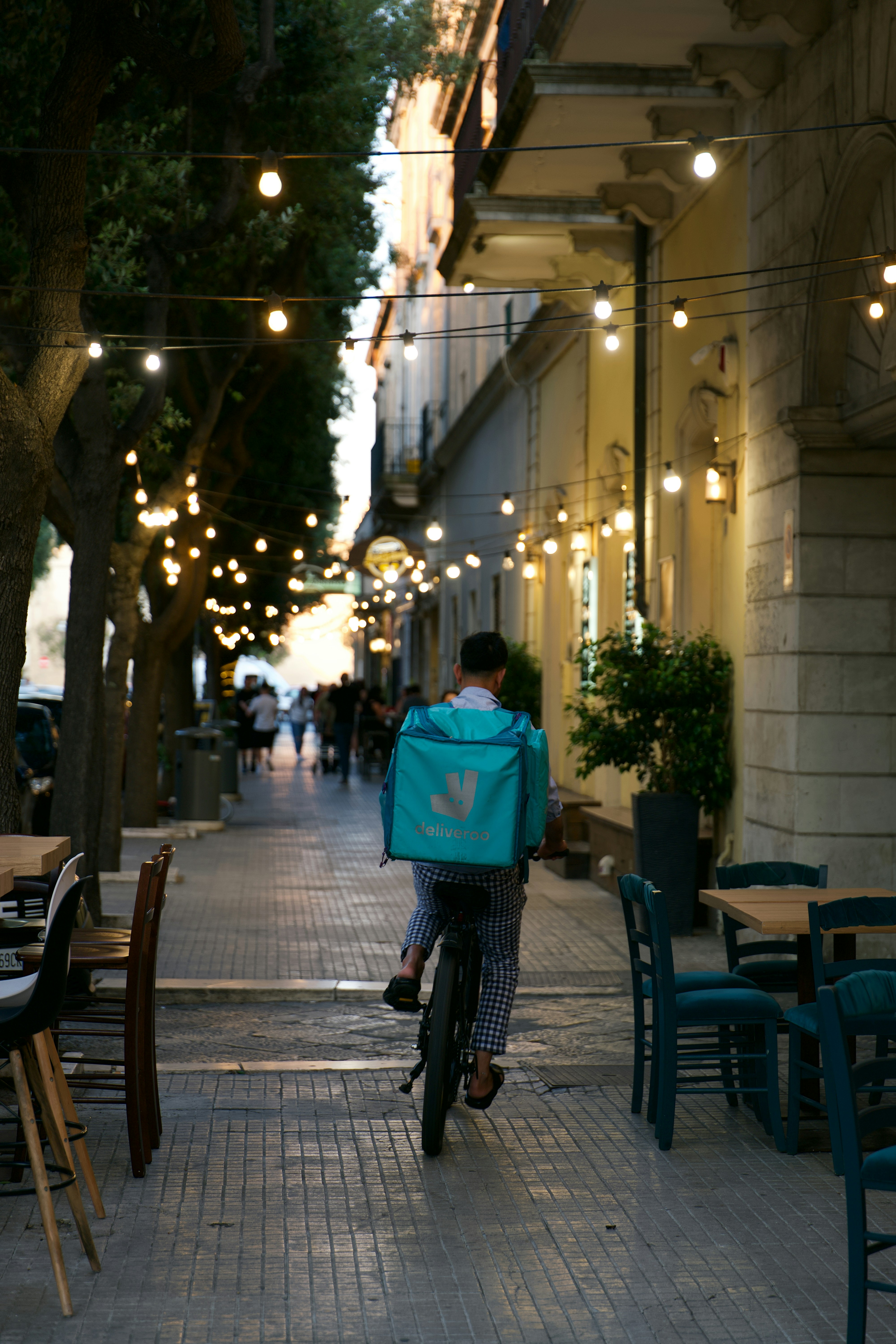 Blue Courier on a Lantern-Lit City Walk
