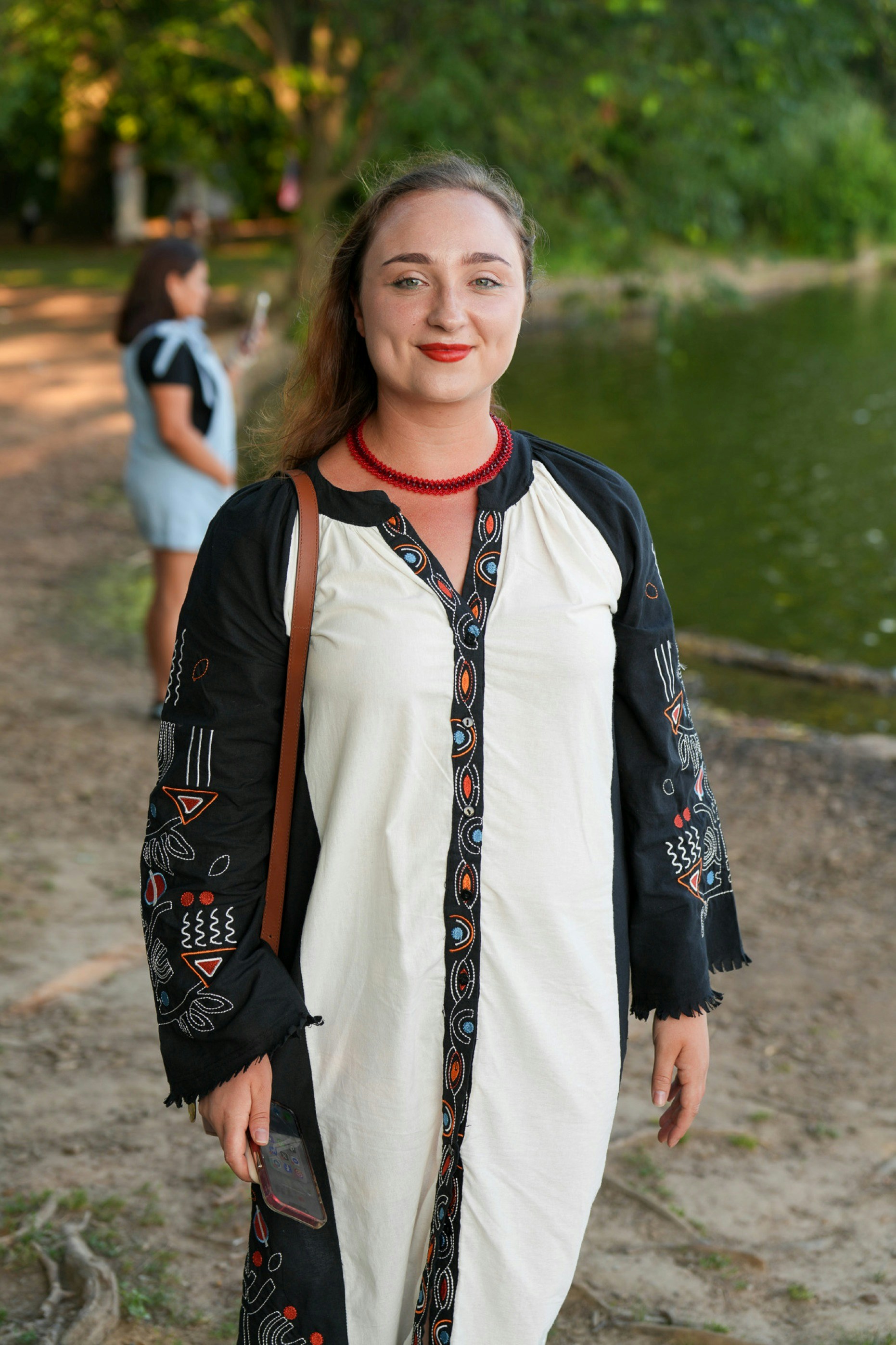Confident Portrait by the Lakeside in Embroidered Attire