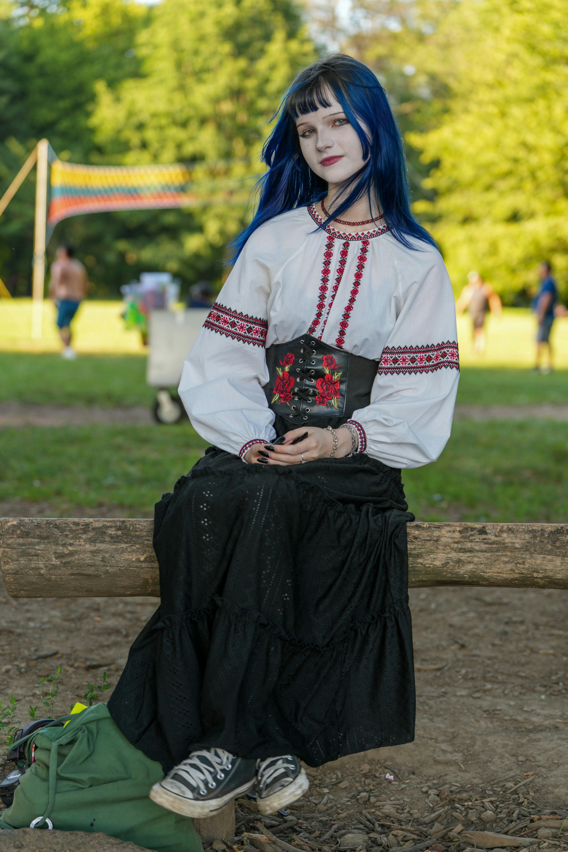 Portrait in Traditional Attire: A Quiet Moment by the Park Fence