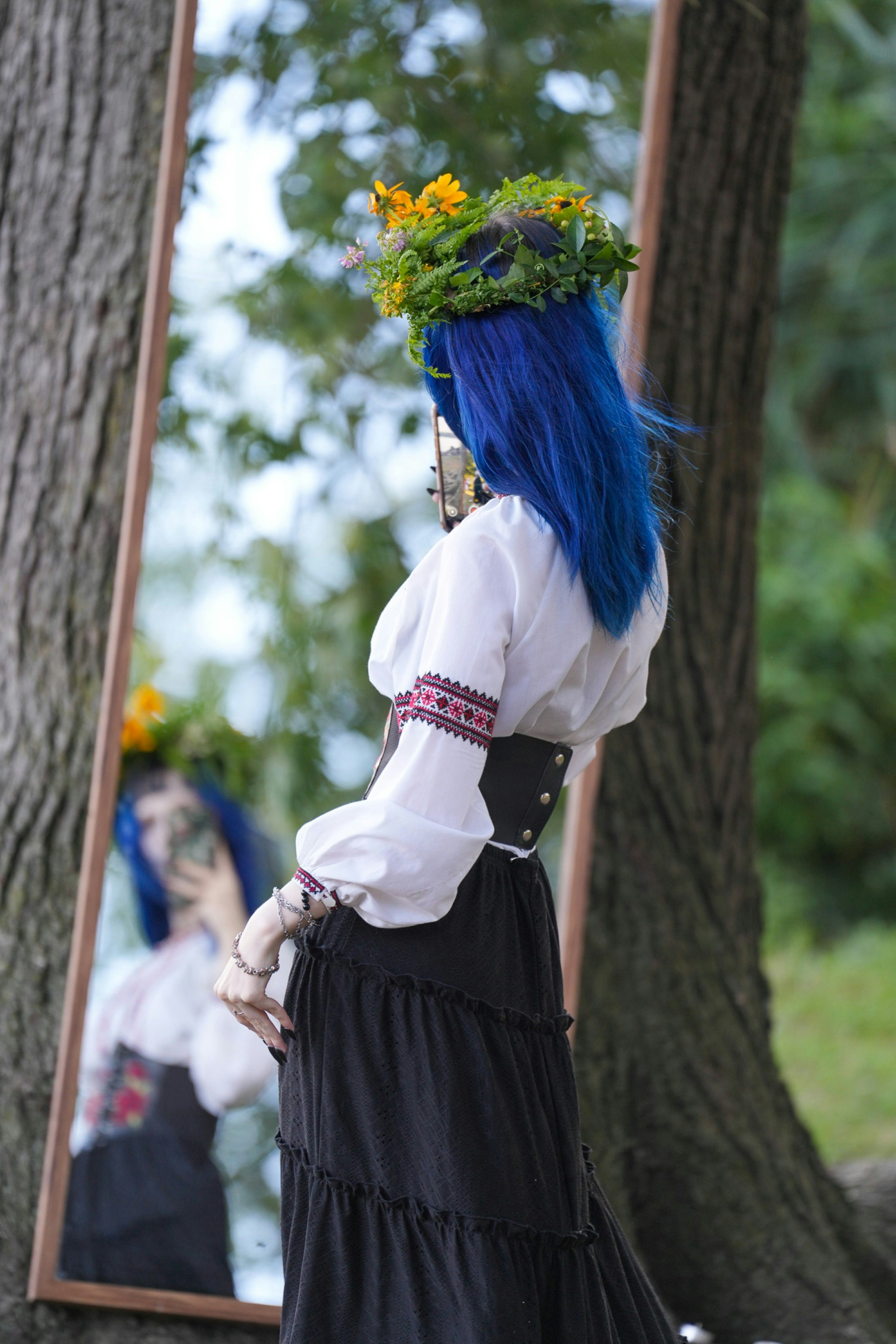 Blue-Rooted Muse in a Floral Crown Before a Mirror