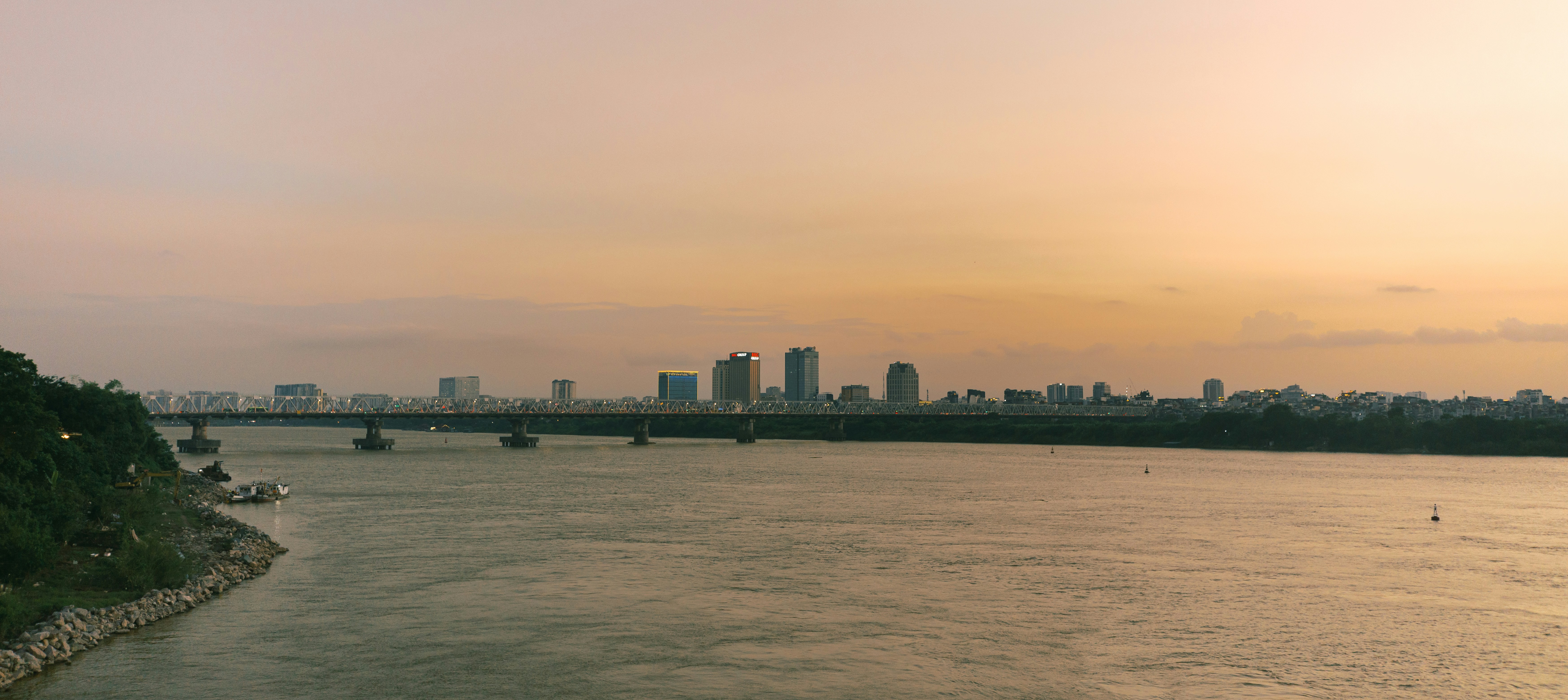 River Skyline at Dusk: Bridges and City Silhouette