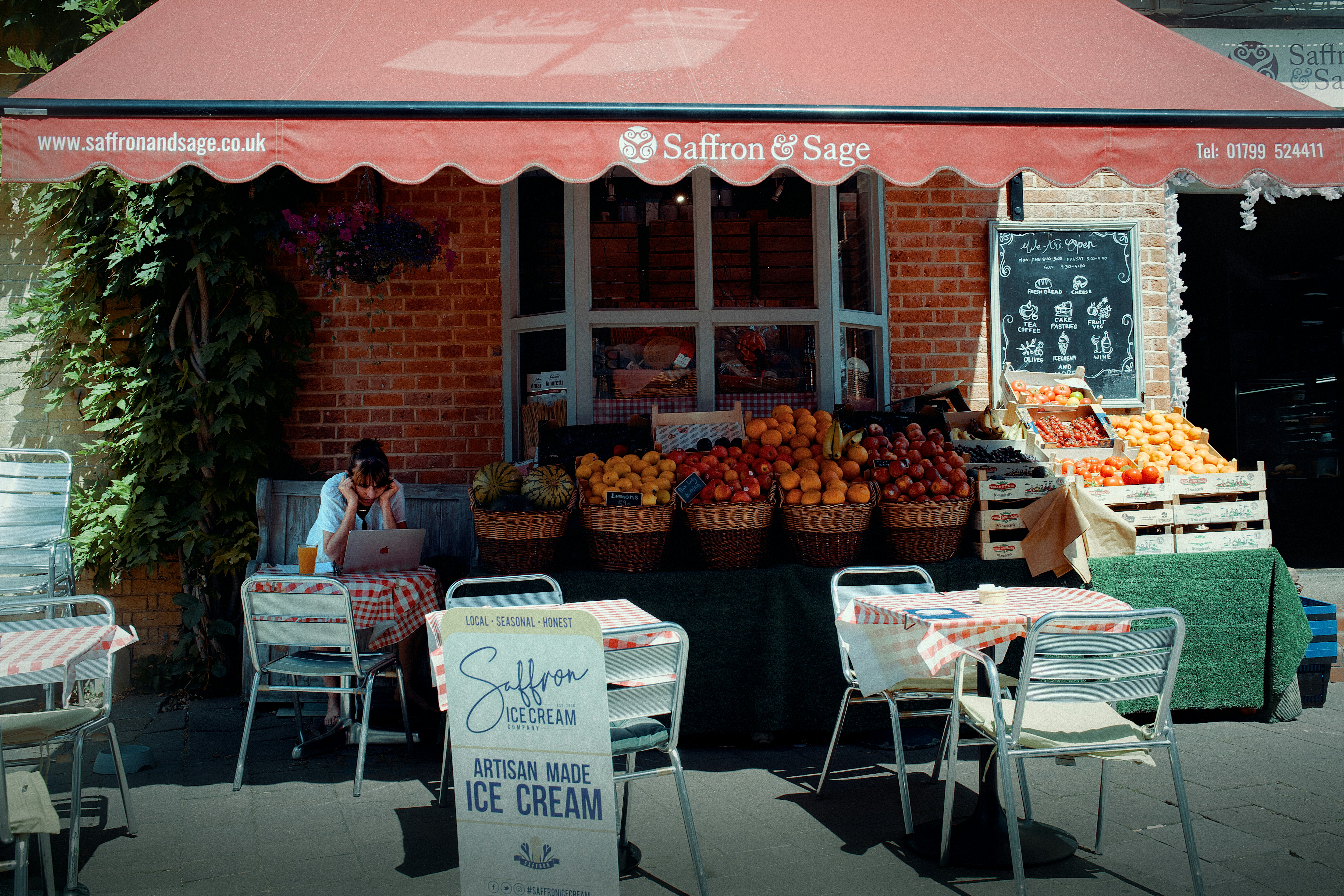 Sunlit Produce Stand Under a Cozy Red Canopy