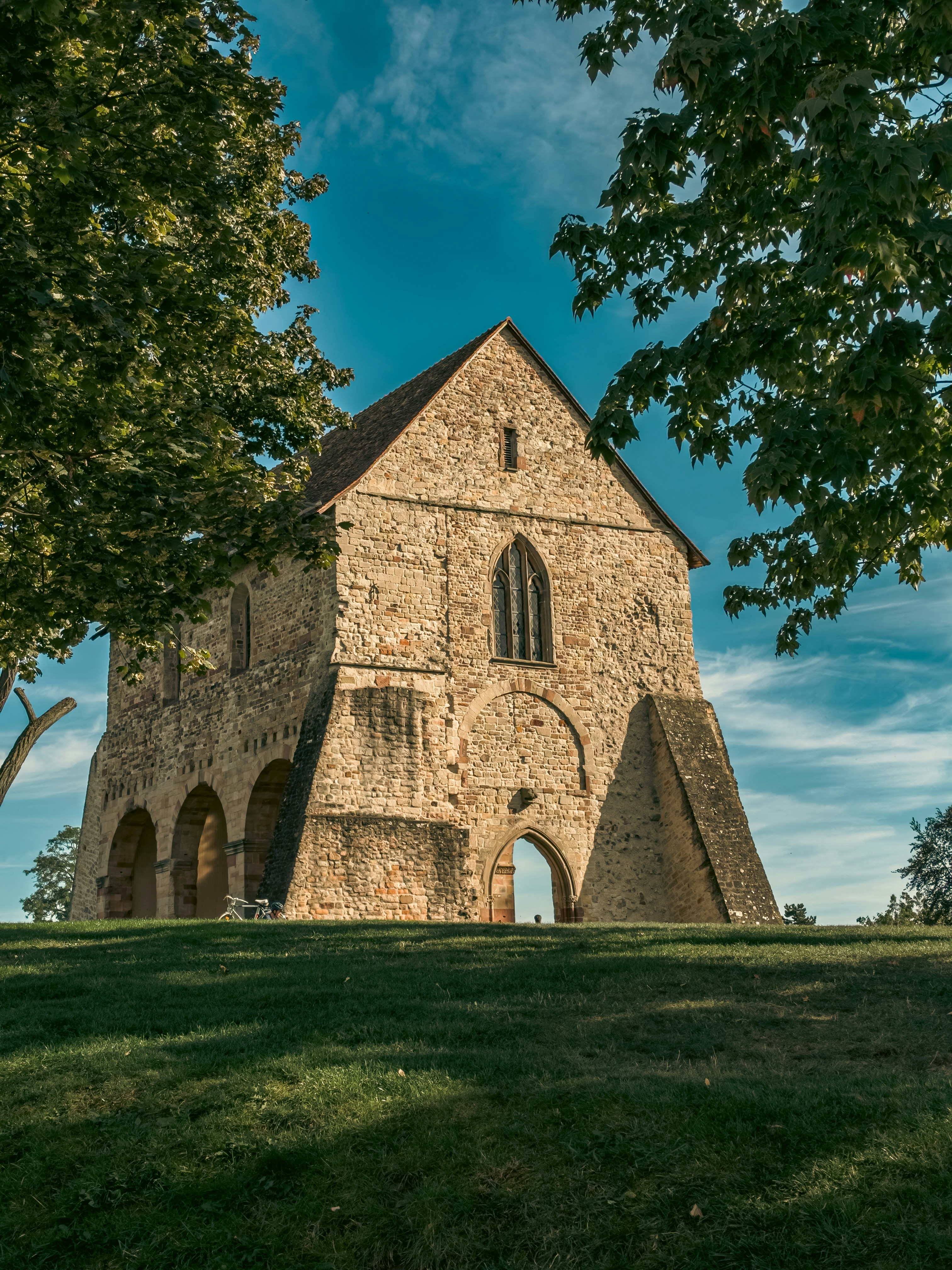 Stone Chapel Rising from the Green: A Sunlit Ruin