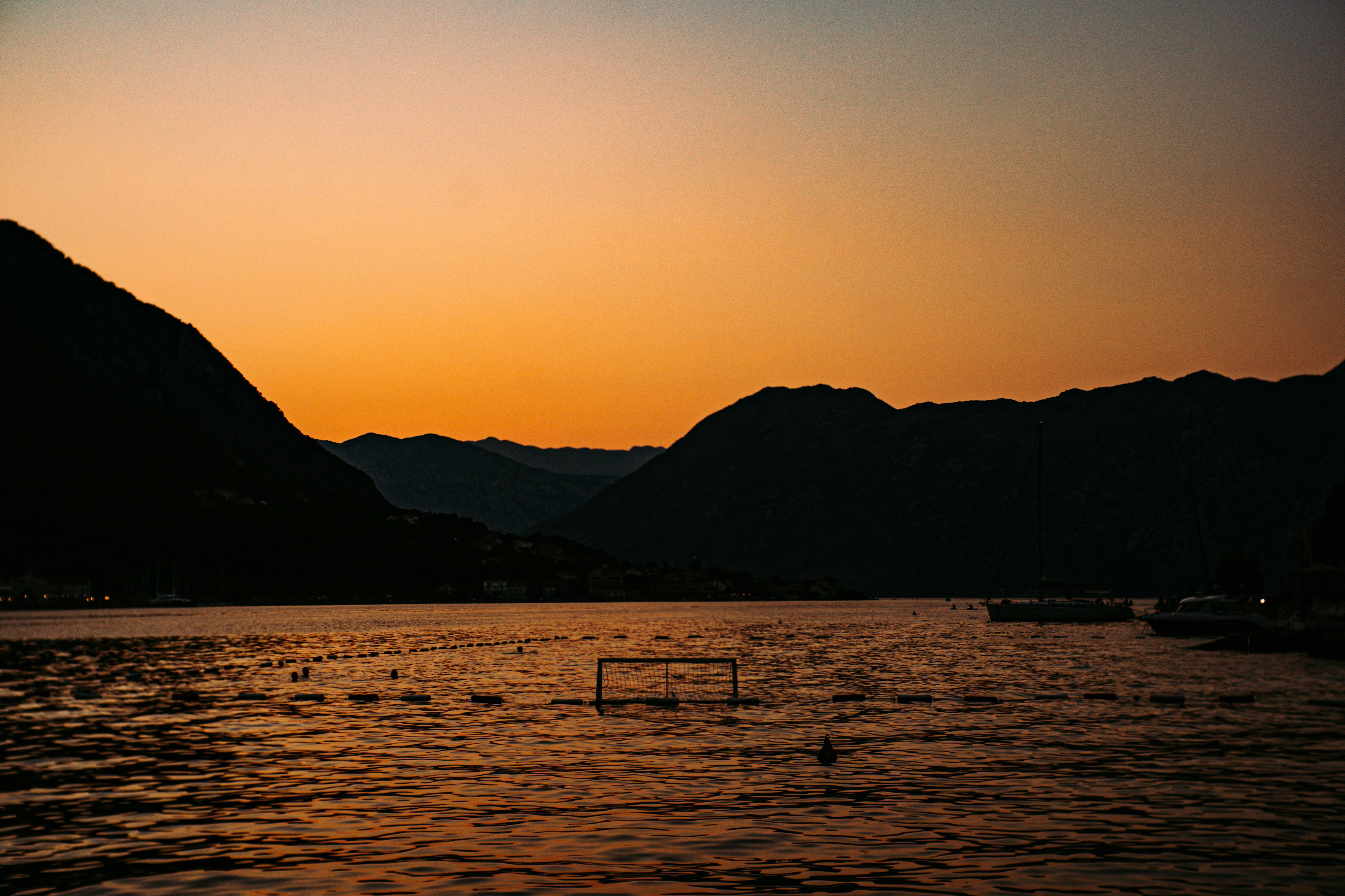 Silhouetted Cove at Sunset with a Submerged Goalpost