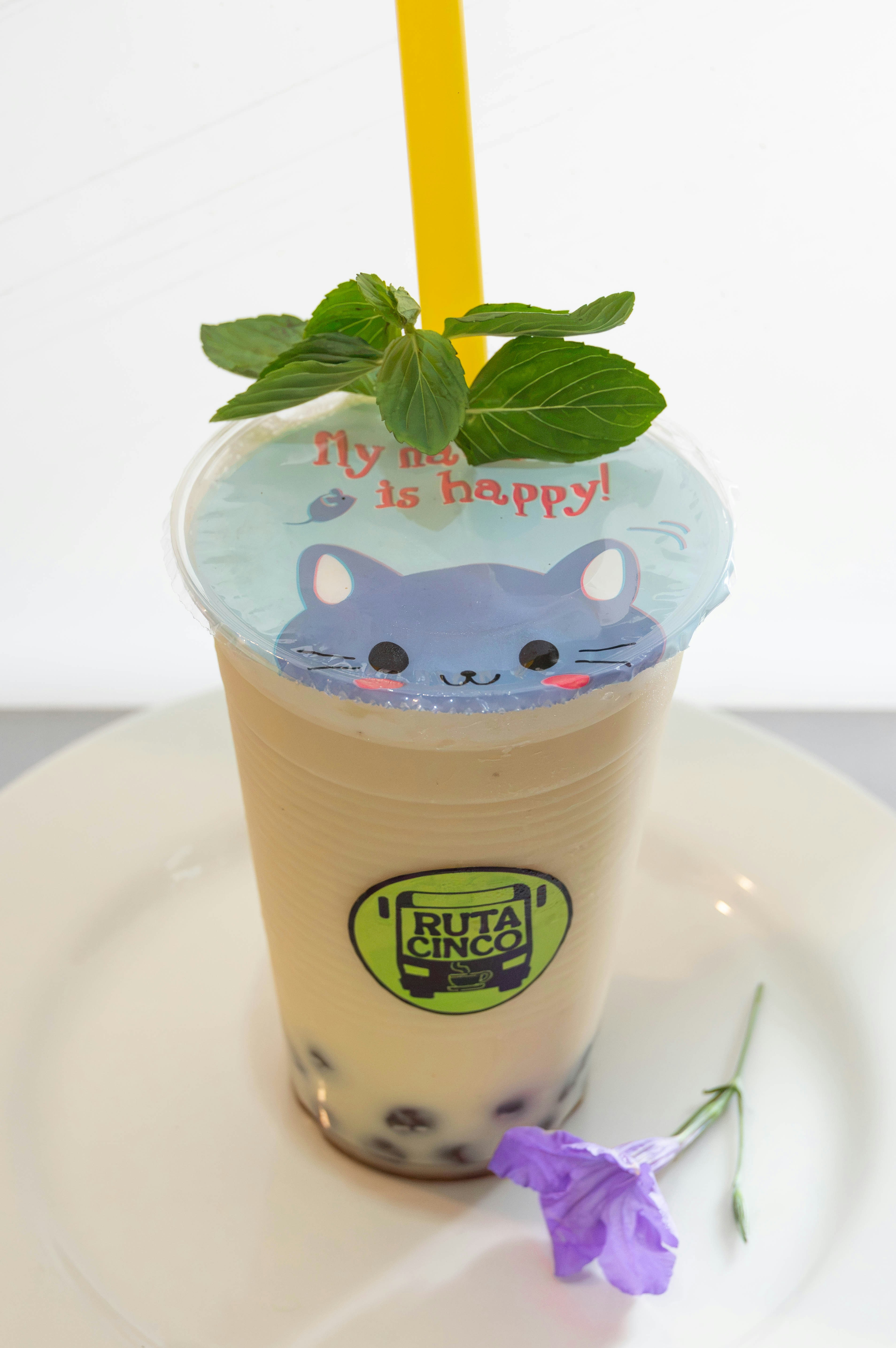 Minty Delight: A Cute Cat-Themed Beverage with Purple Flower