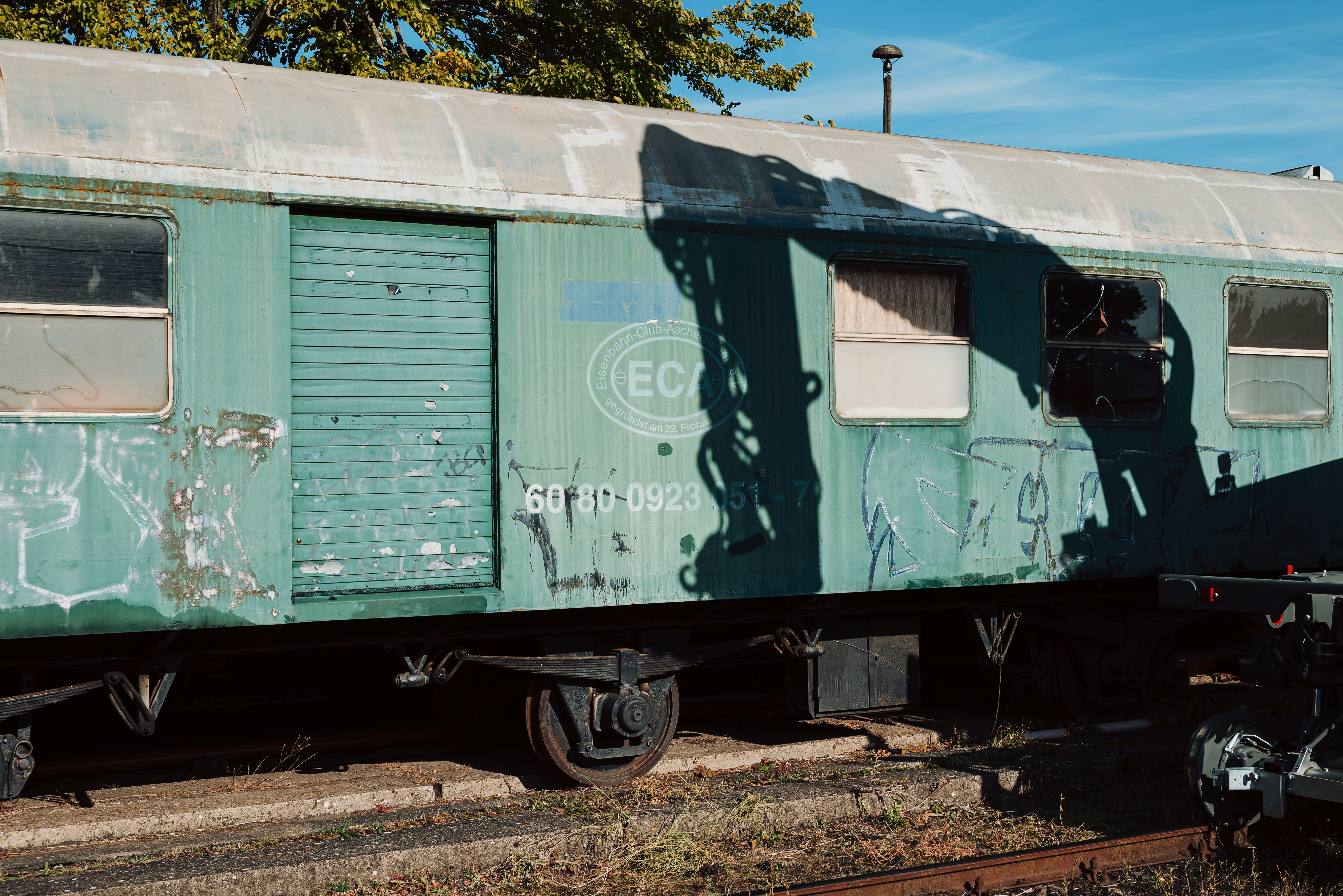 Shadowed Silhouette on a Weathered Railcar