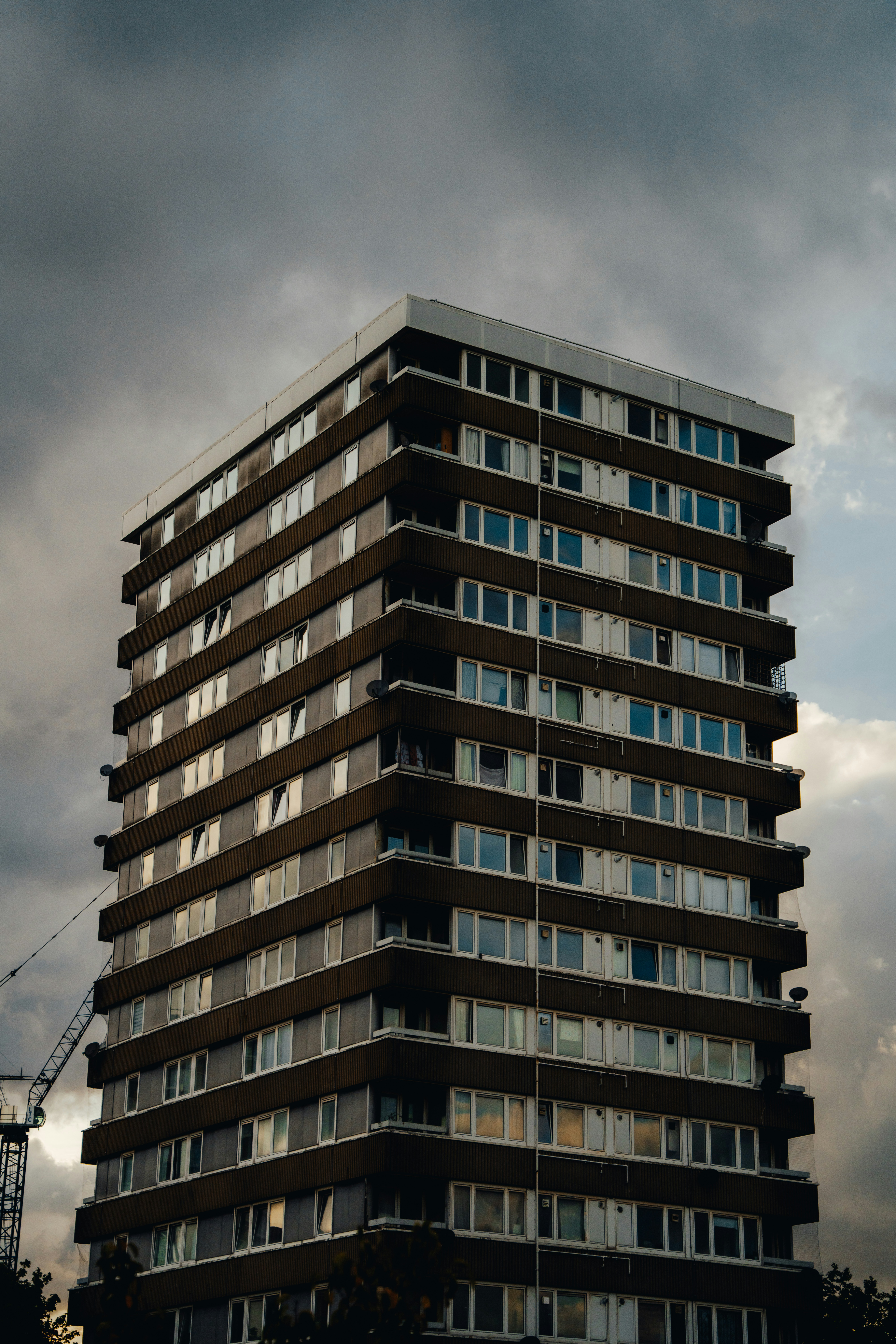 Vertical Prism: A Leaning Skyline of Flats Against a Stormy Sky