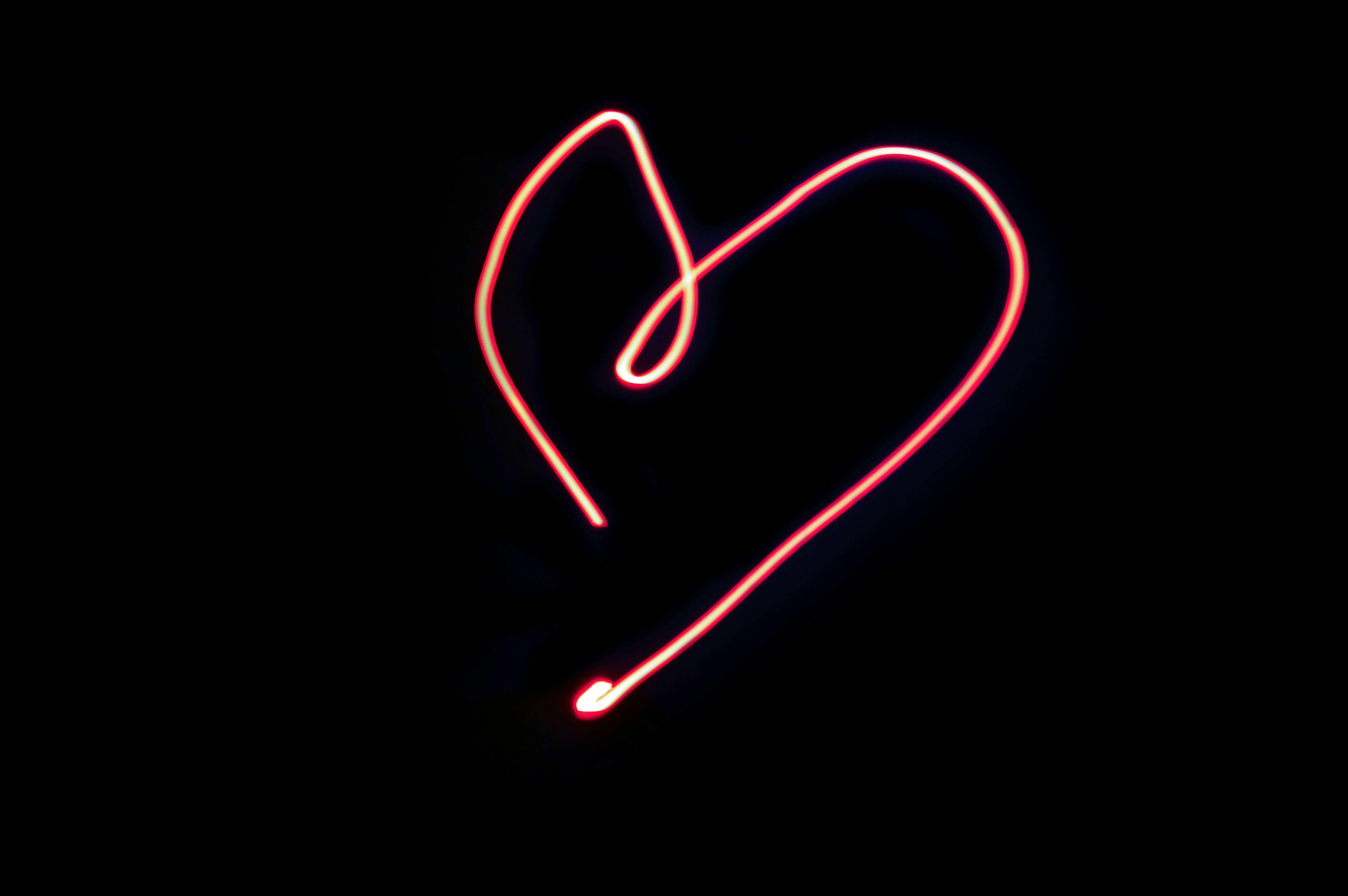 Neon Heart Traced in Night: A Minimal Light-Painting Portrait
