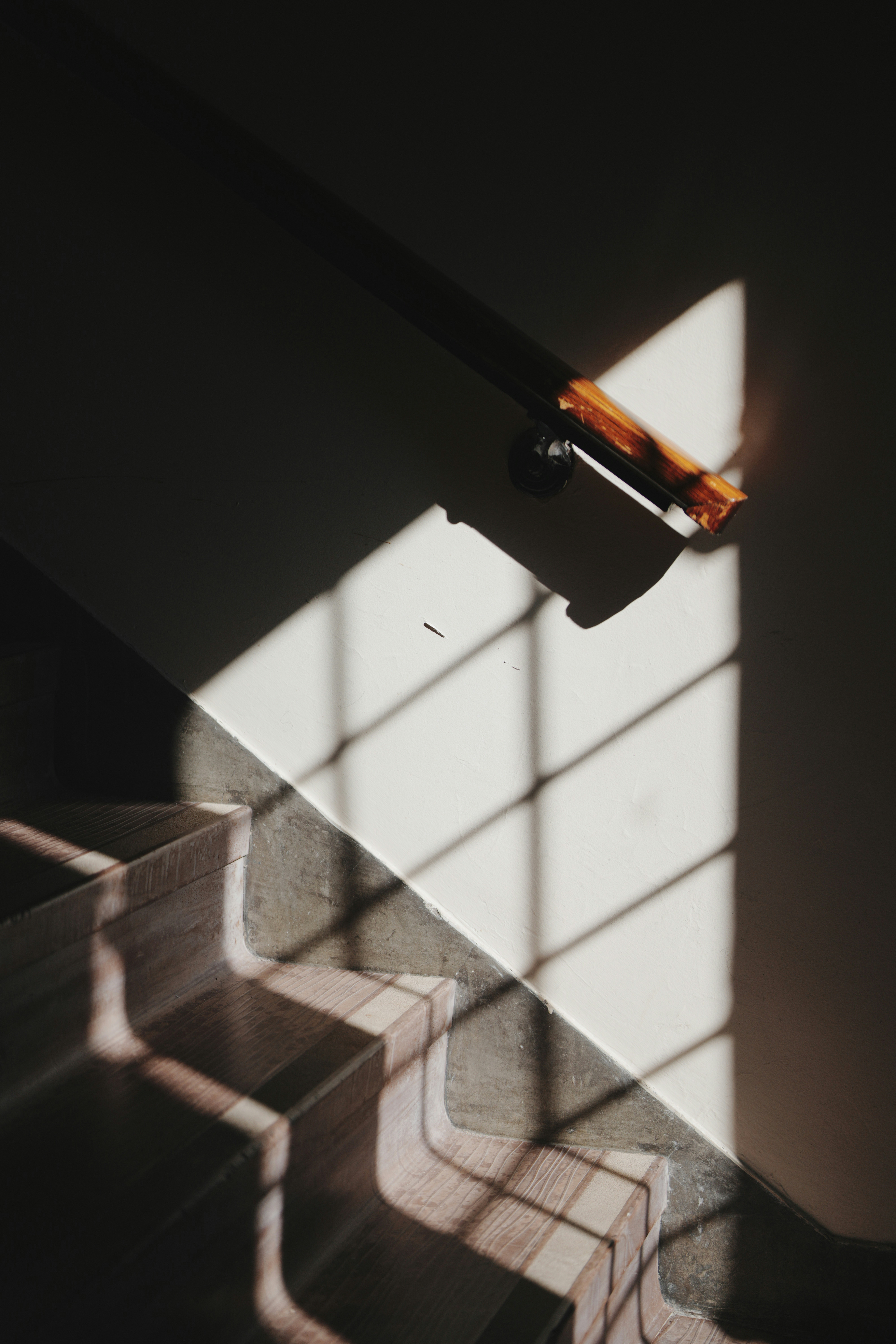 Shadowed Staircase and Window Grid in Sunbeam